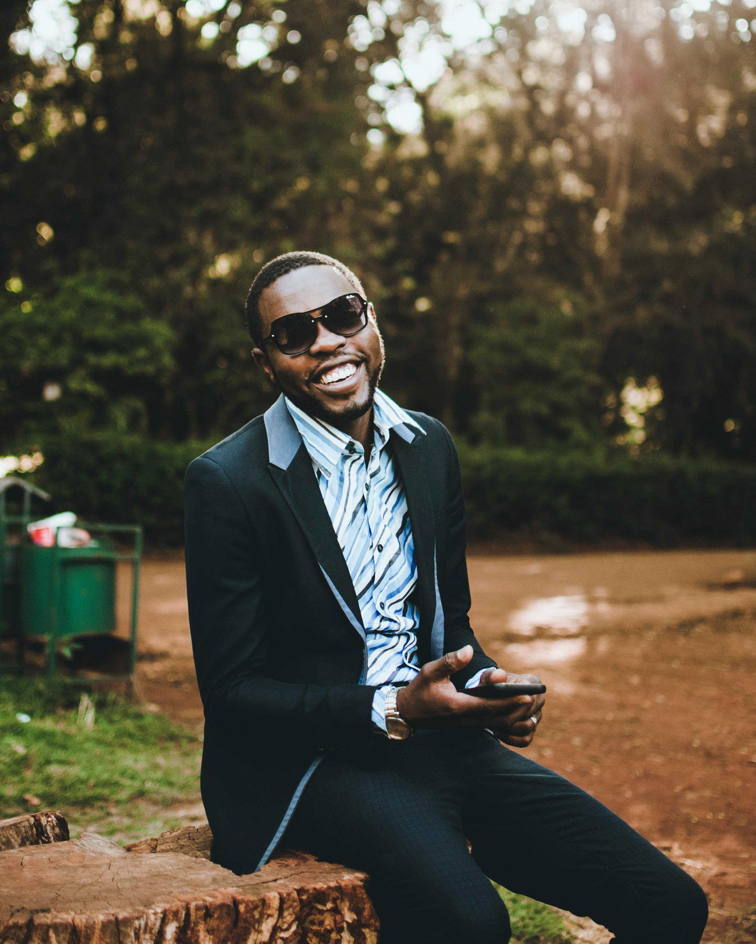 A Man Wearing a Cape Walking on a Field · Free Stock Photo