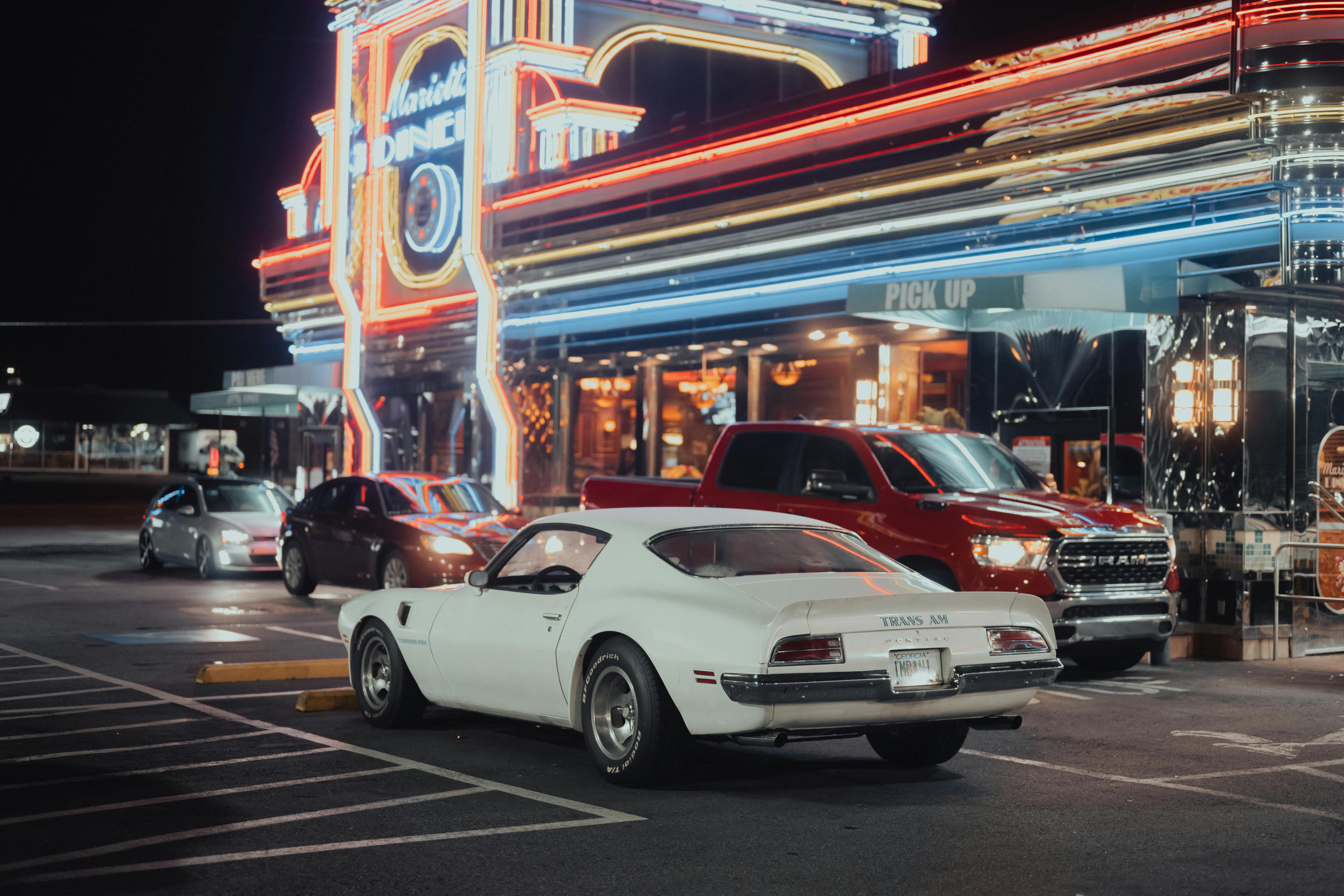 Pontiac Firebird and Cars near Building at Night · Free Stock Photo
