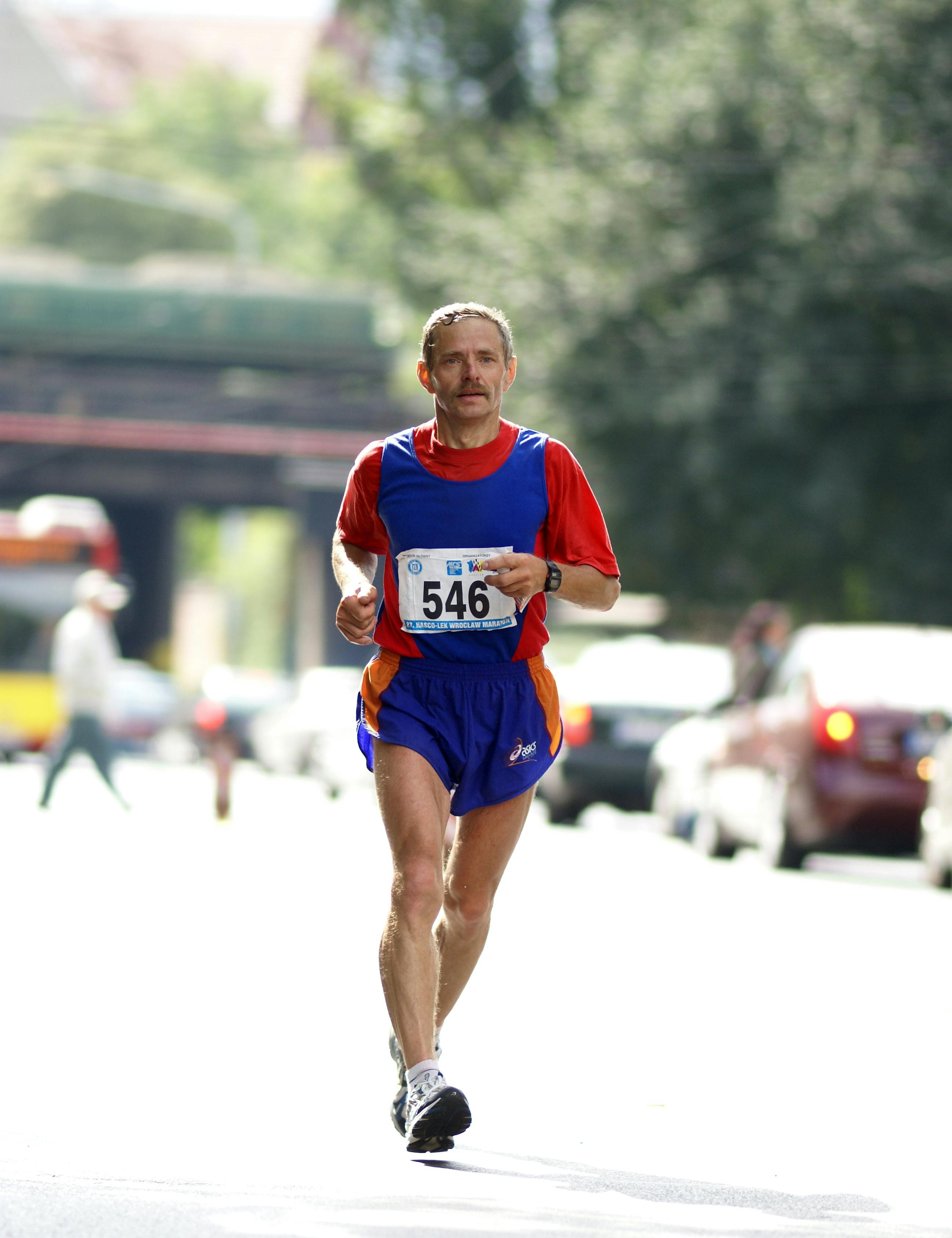 A Man Running a Marathon in City · Free Stock Photo