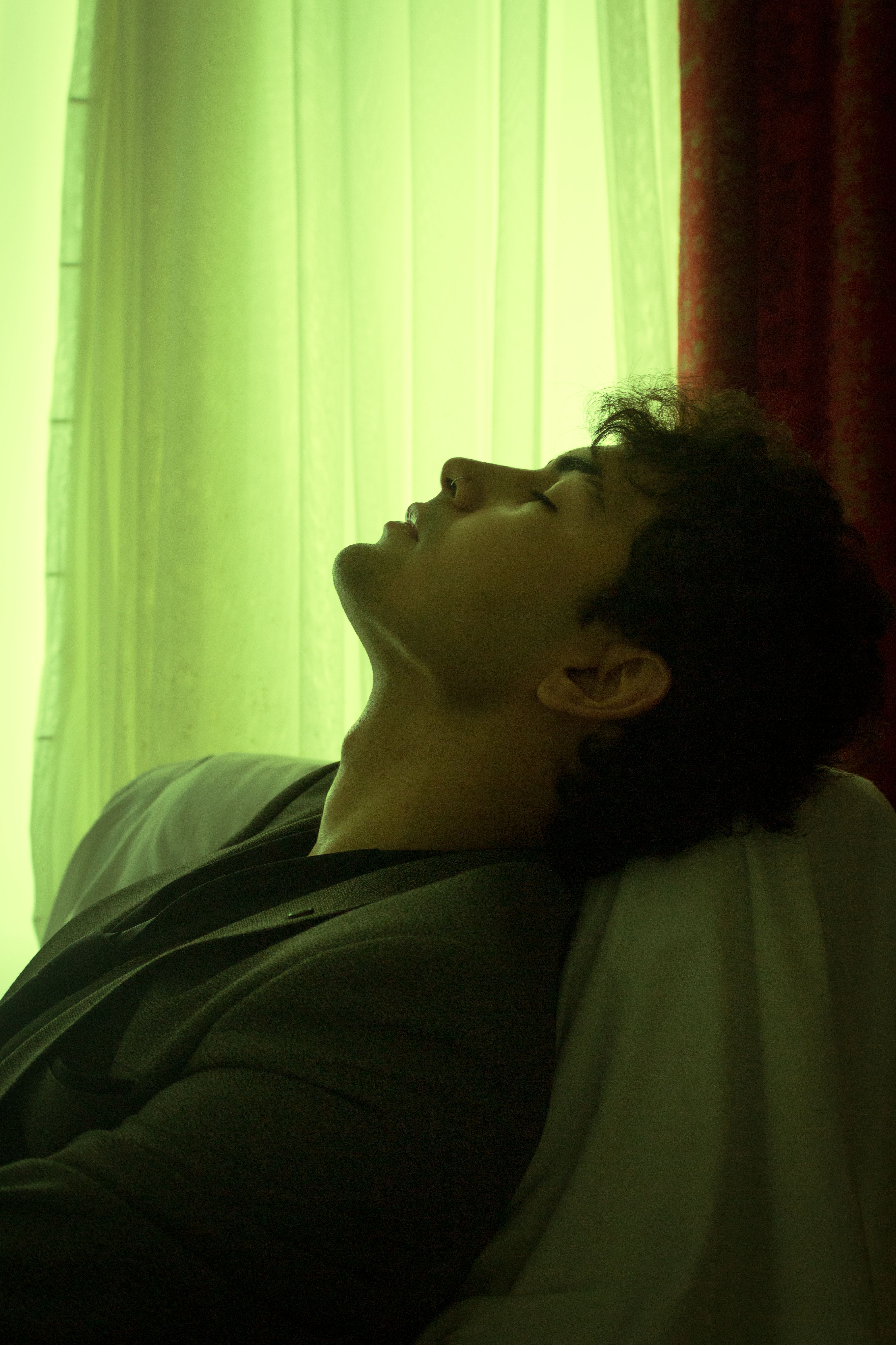 Closeup of a Man Taking a Nap in a Room with Curtains · Free Stock Photo