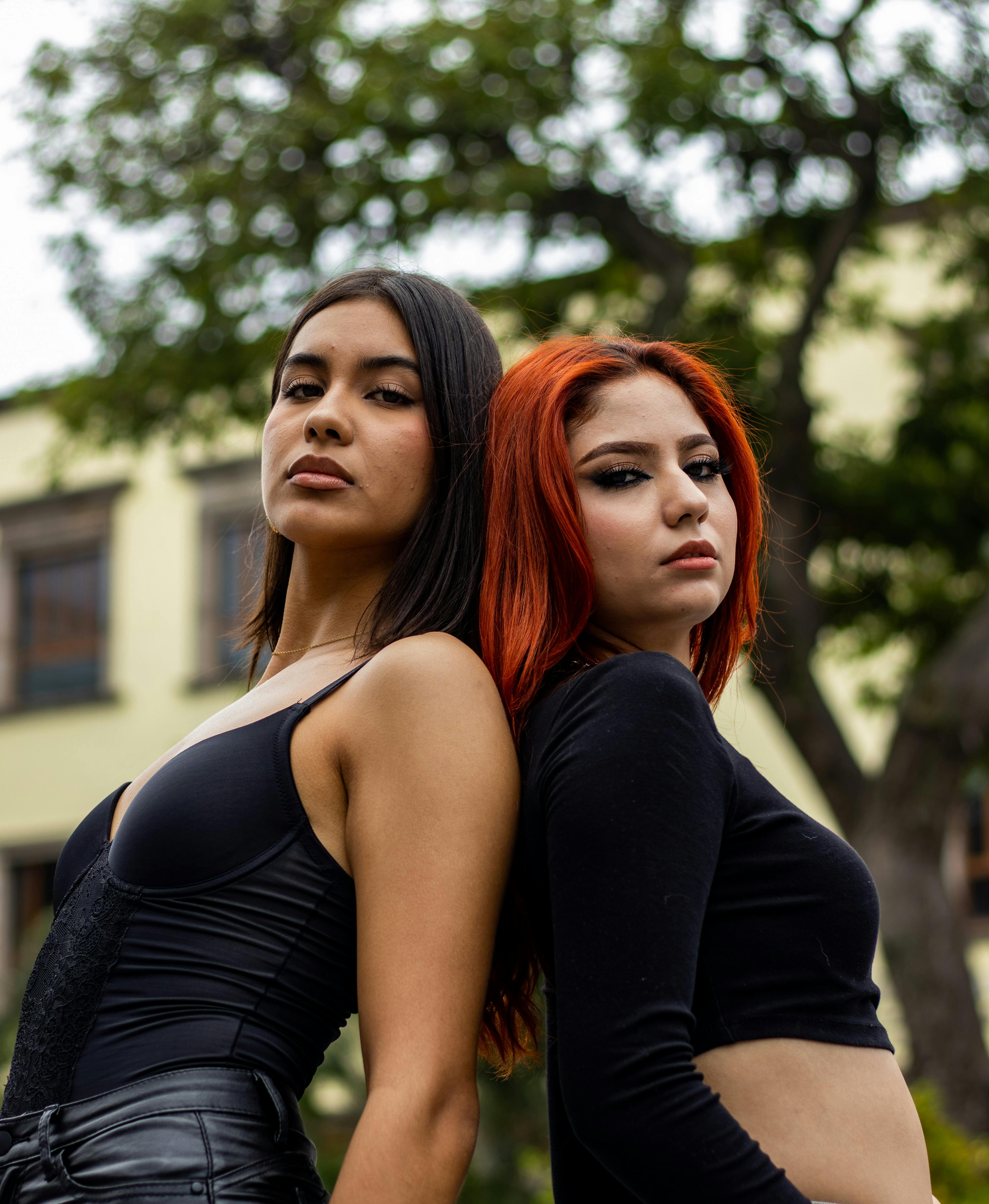 Two Female Models Posing Back to Back · Free Stock Photo