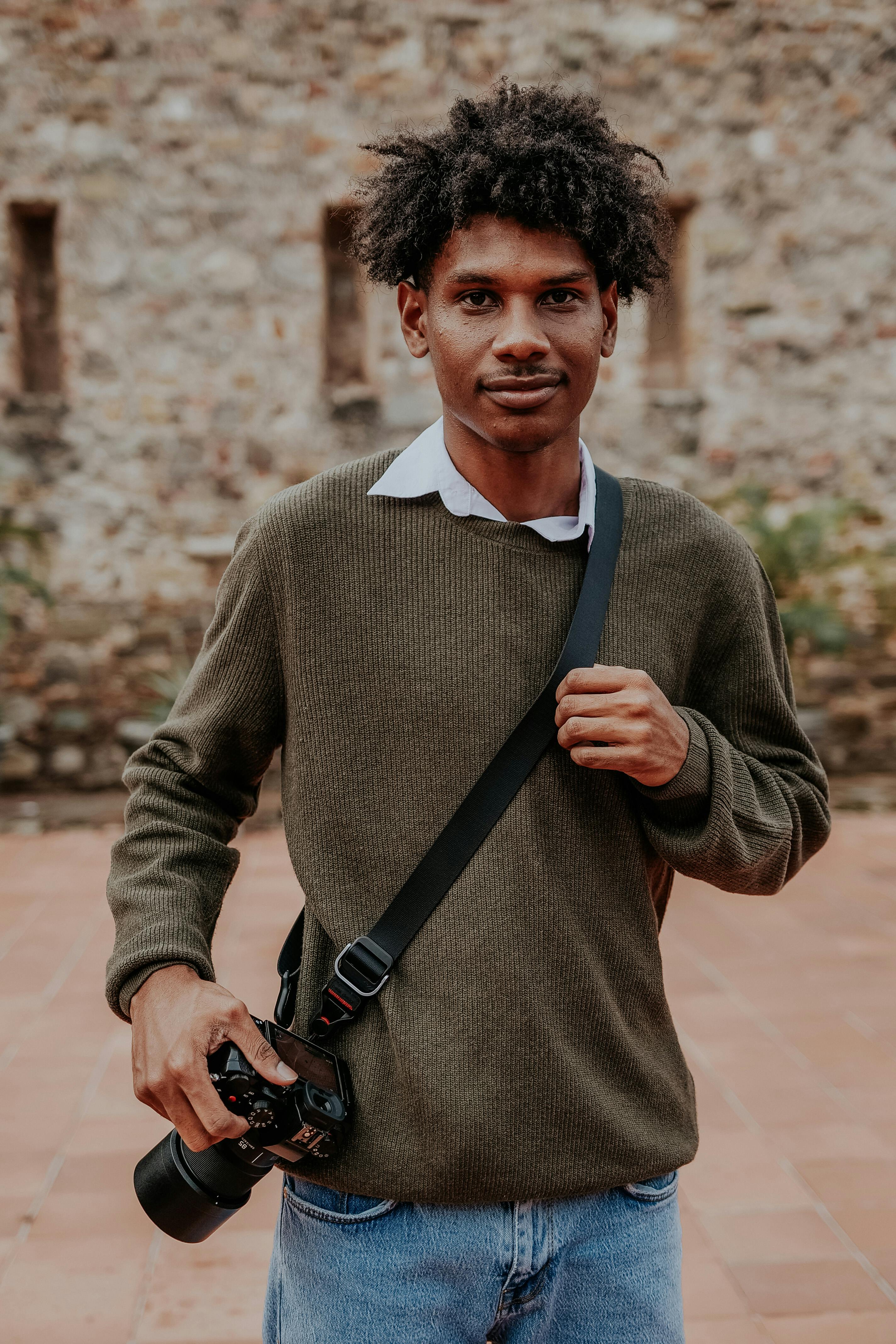 Man Wearing Jacket Holding Dslr Camera · Free Stock Photo