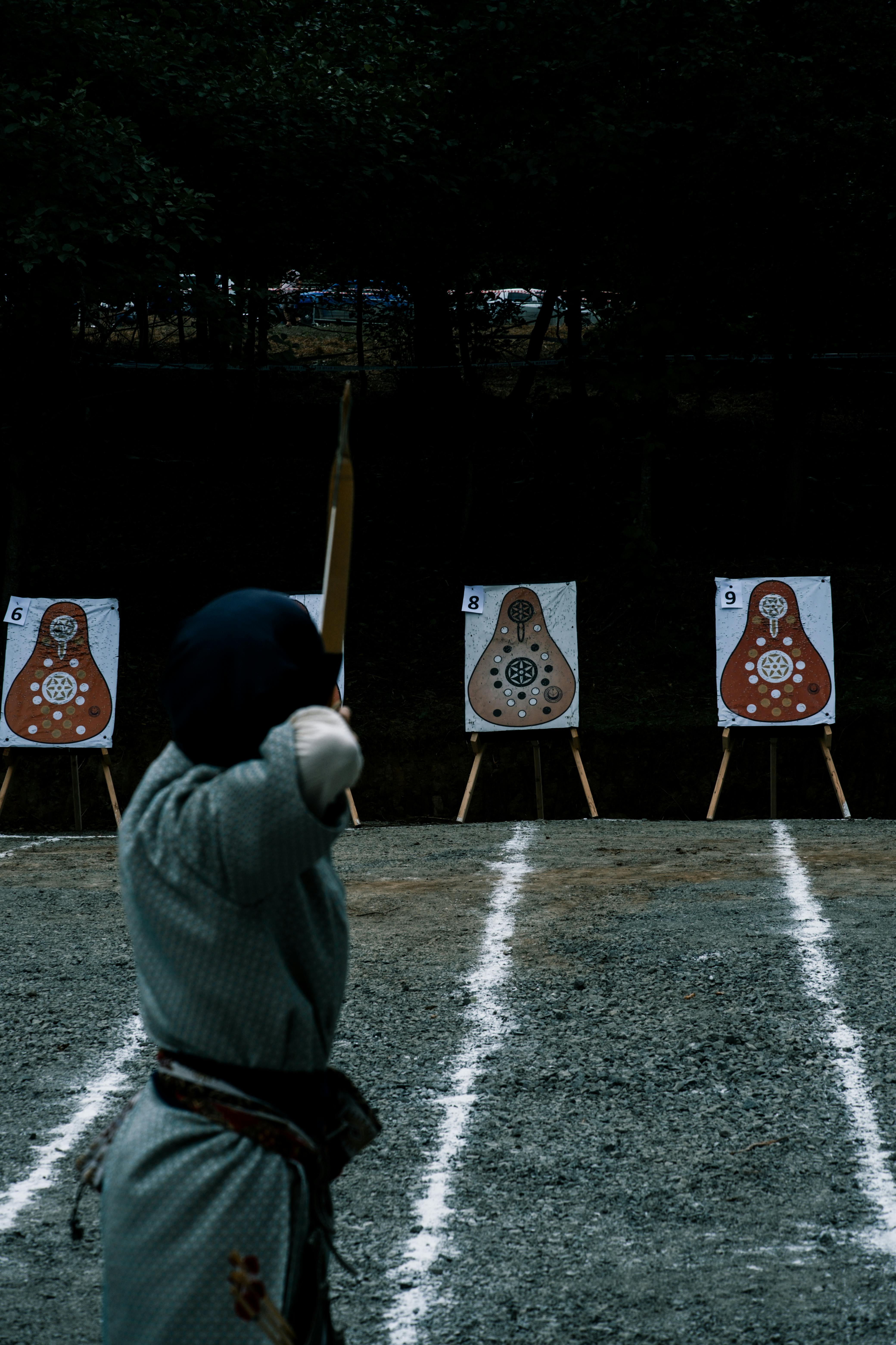 A Person Shooting with a Bow to a Target · Free Stock Photo
