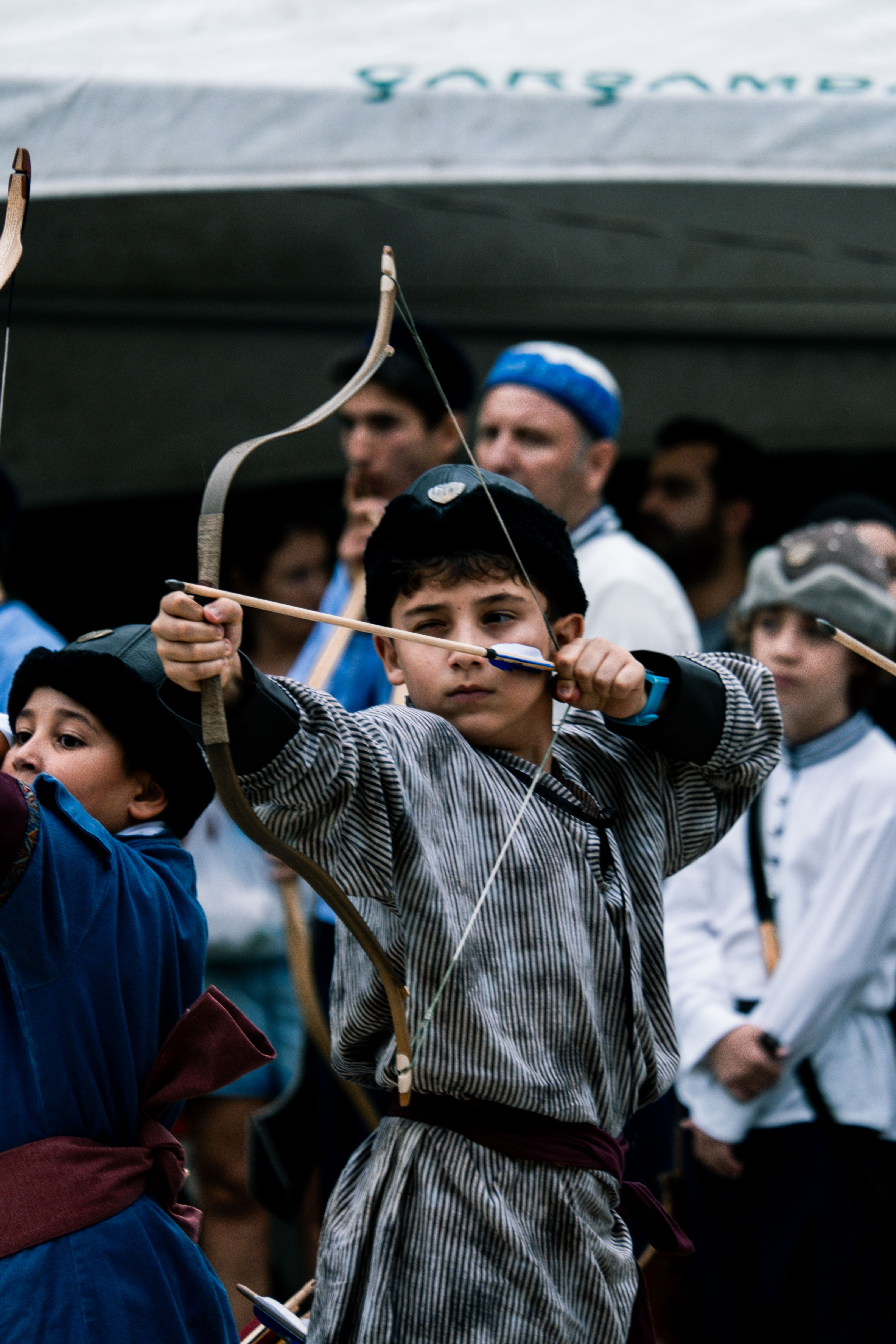 Young Boy in Medieval Costume Shooting Arrows · Free Stock Photo