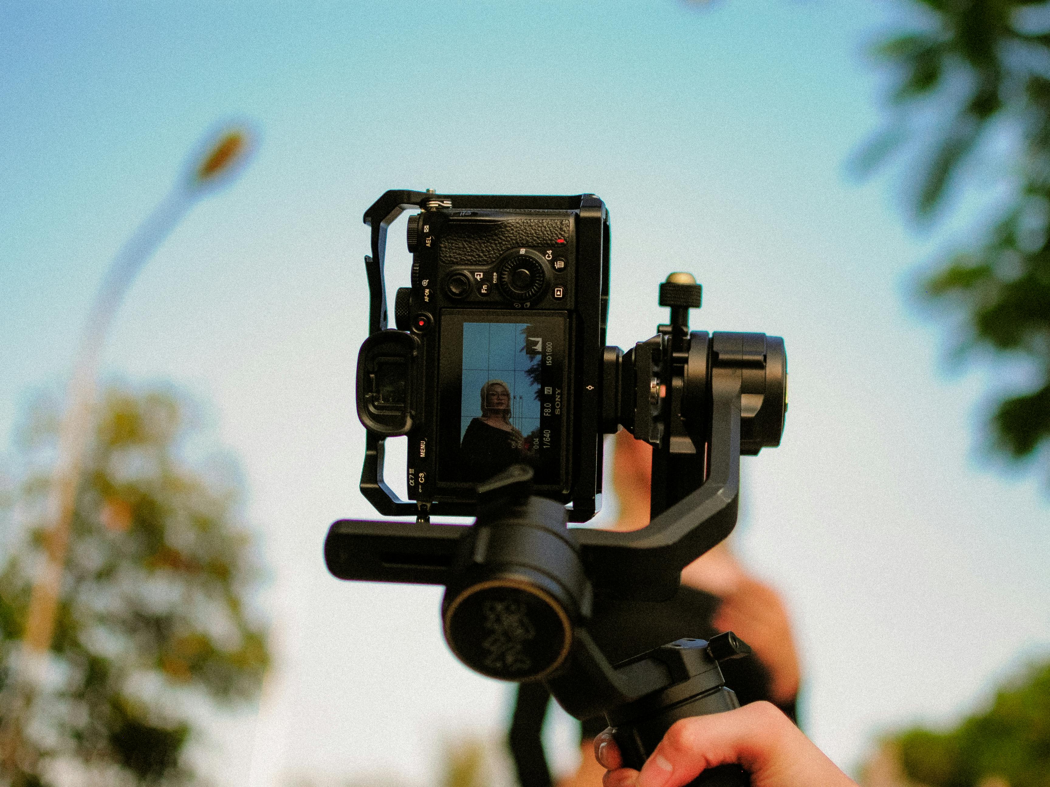 Woman Operating a Professional Camera Filming a Man · Free Stock Photo