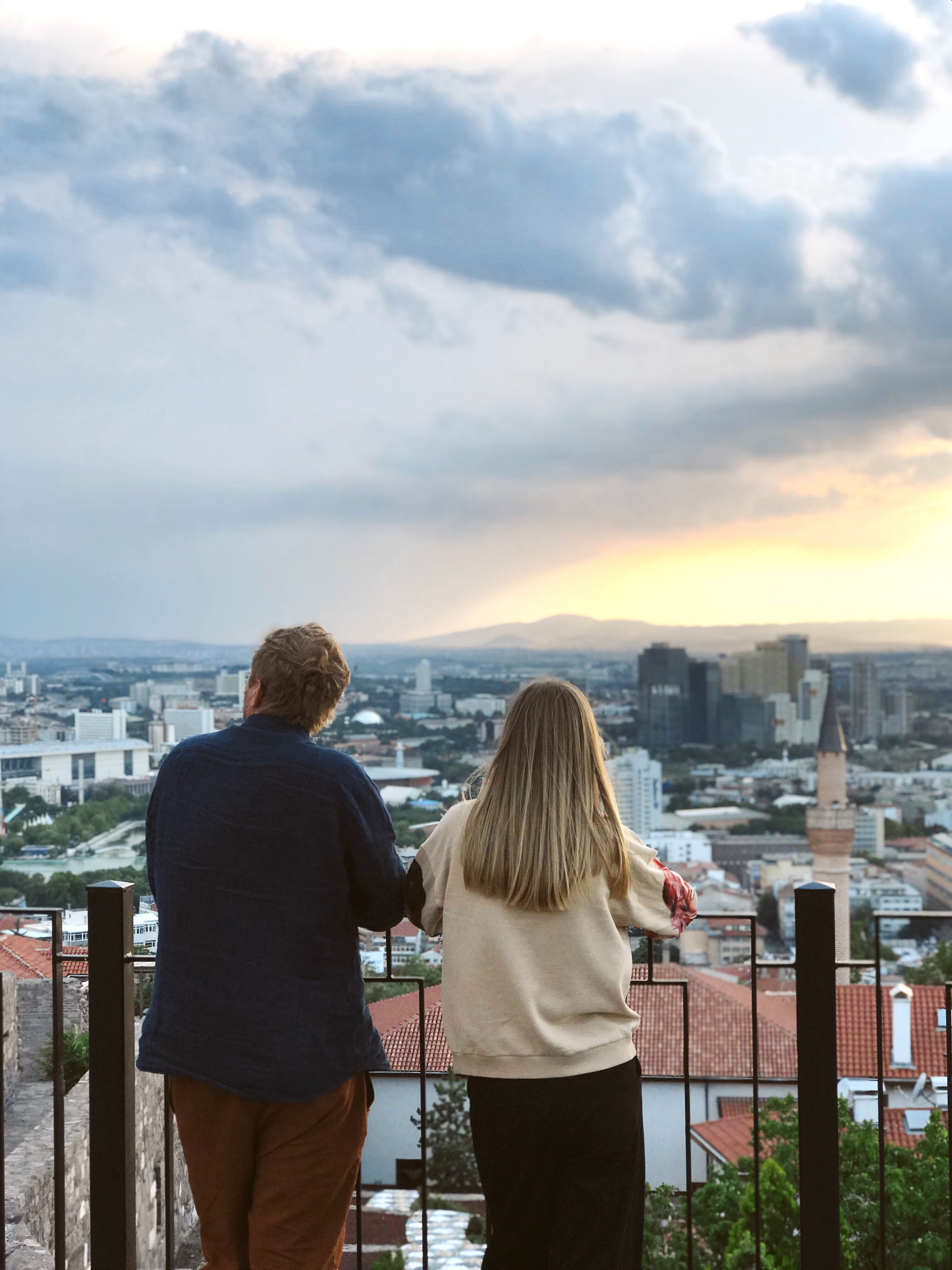 Woman and Man Standing Together with City behind at Sunset · Free Stock ...