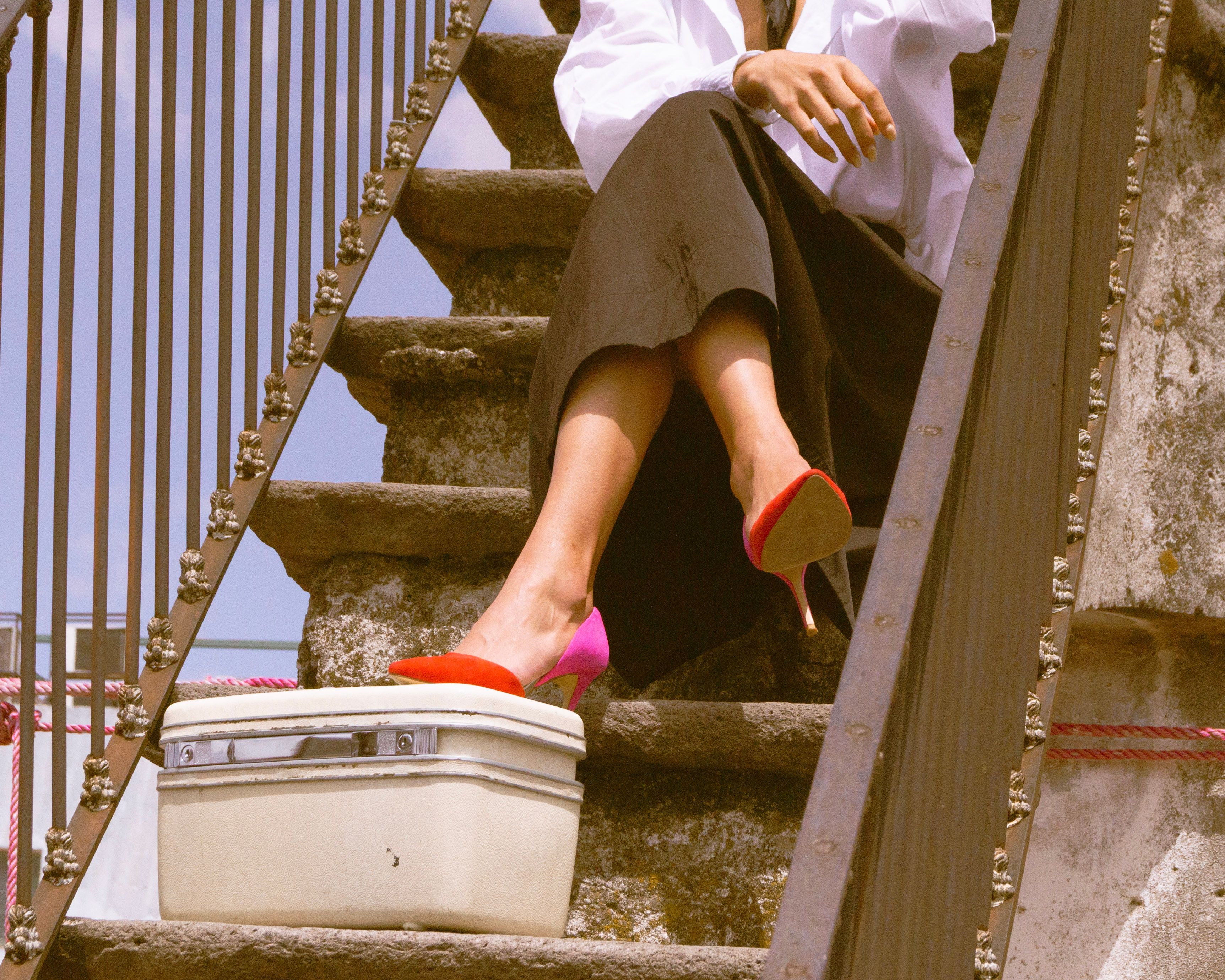 Legs of Woman in High Heels Sitting on Stairs · Free Stock Photo