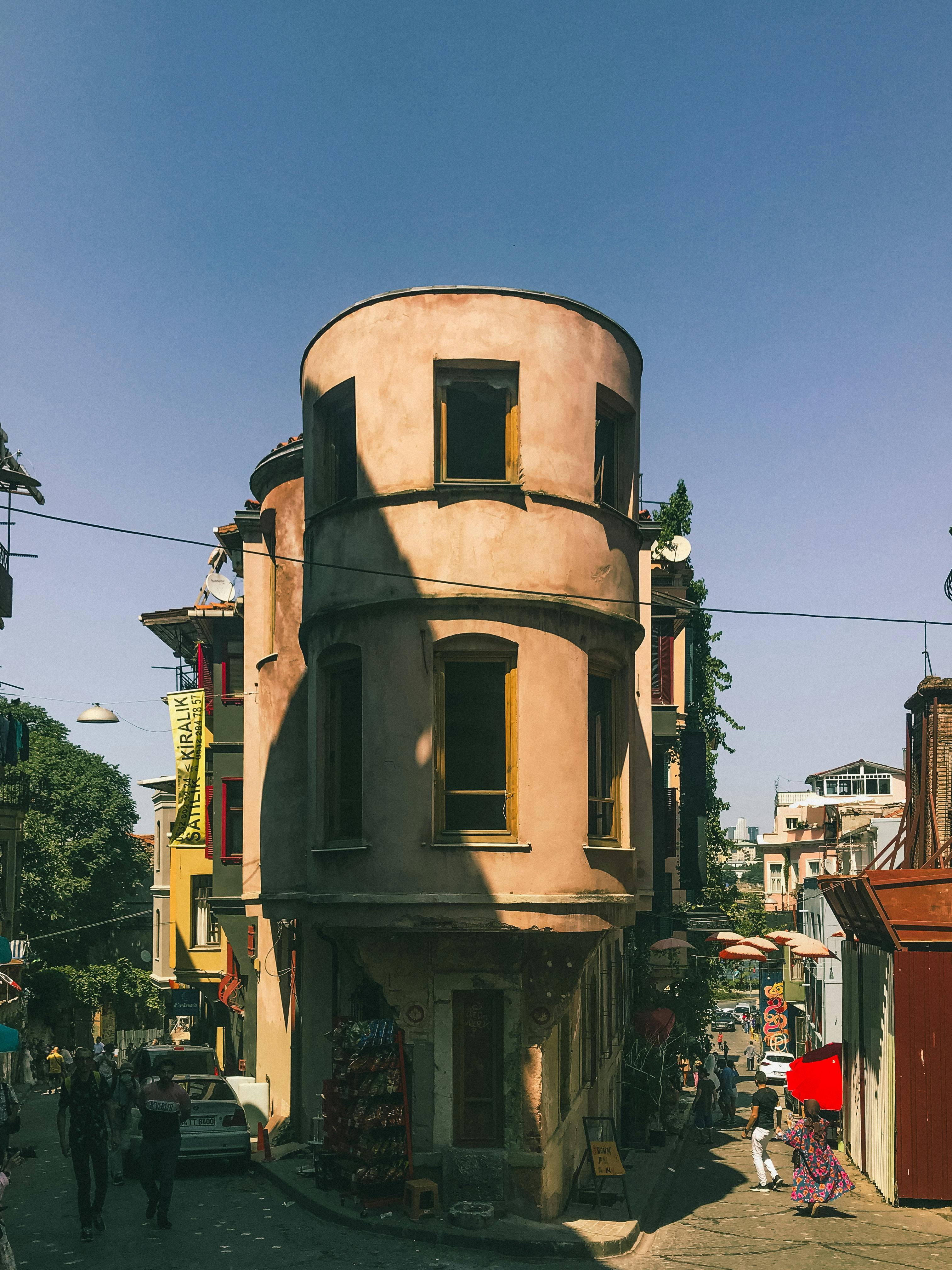 Man Sitting on Steps between Residential Buildings · Free Stock Photo