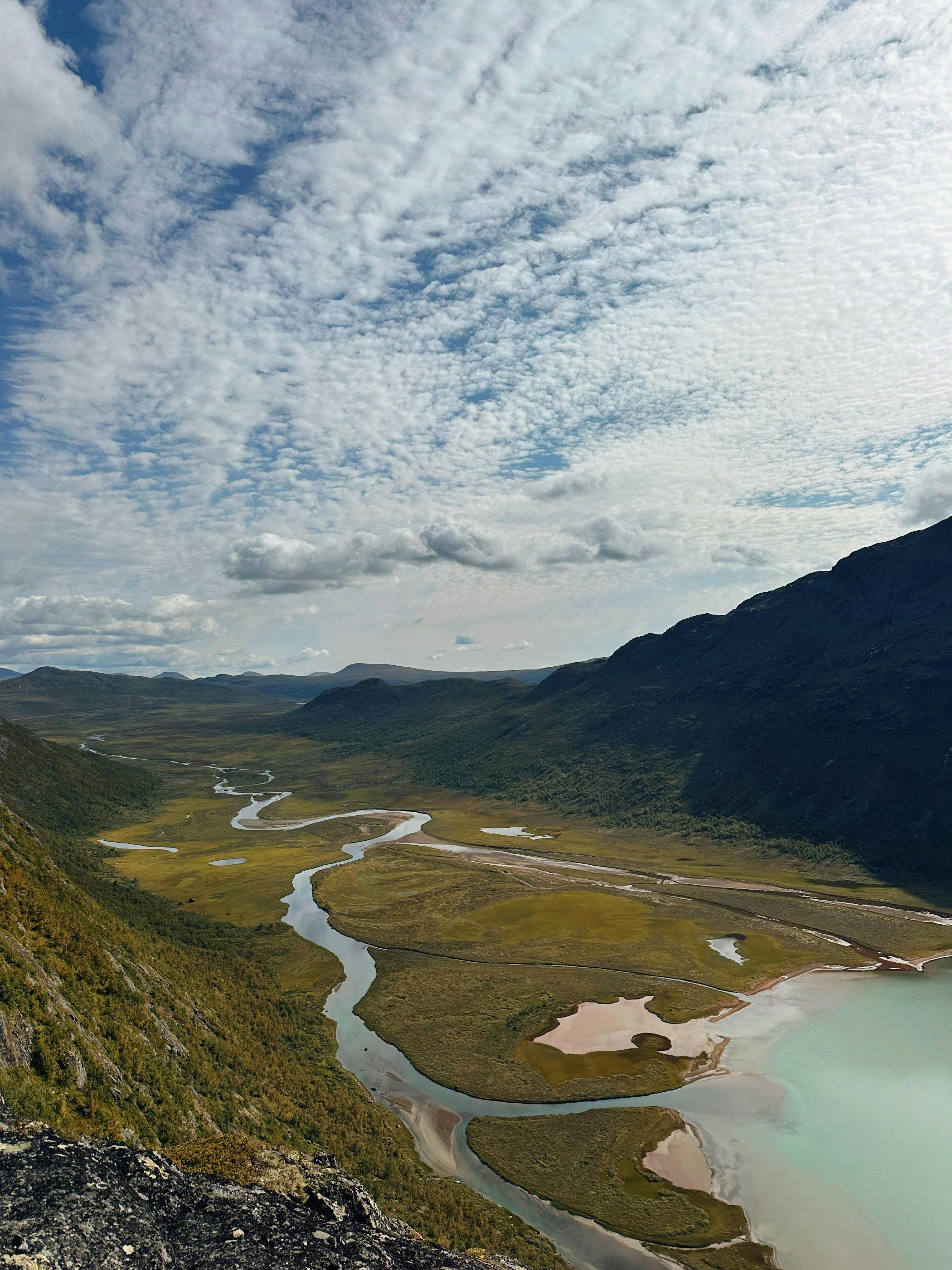 Twisted River Crossing Valley and Ending in Lake · Free Stock Photo