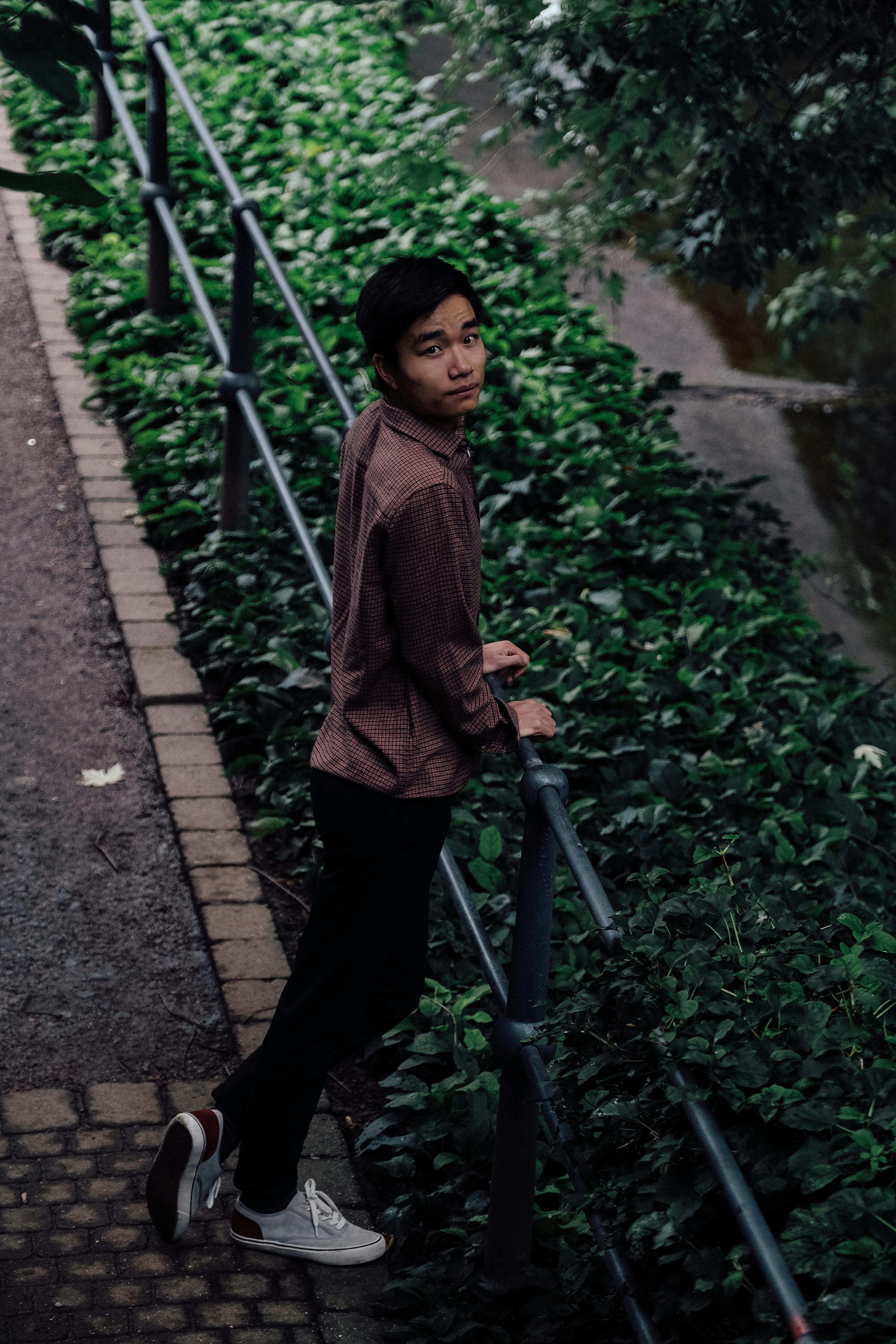 Man Standing Beside Railing · Free Stock Photo