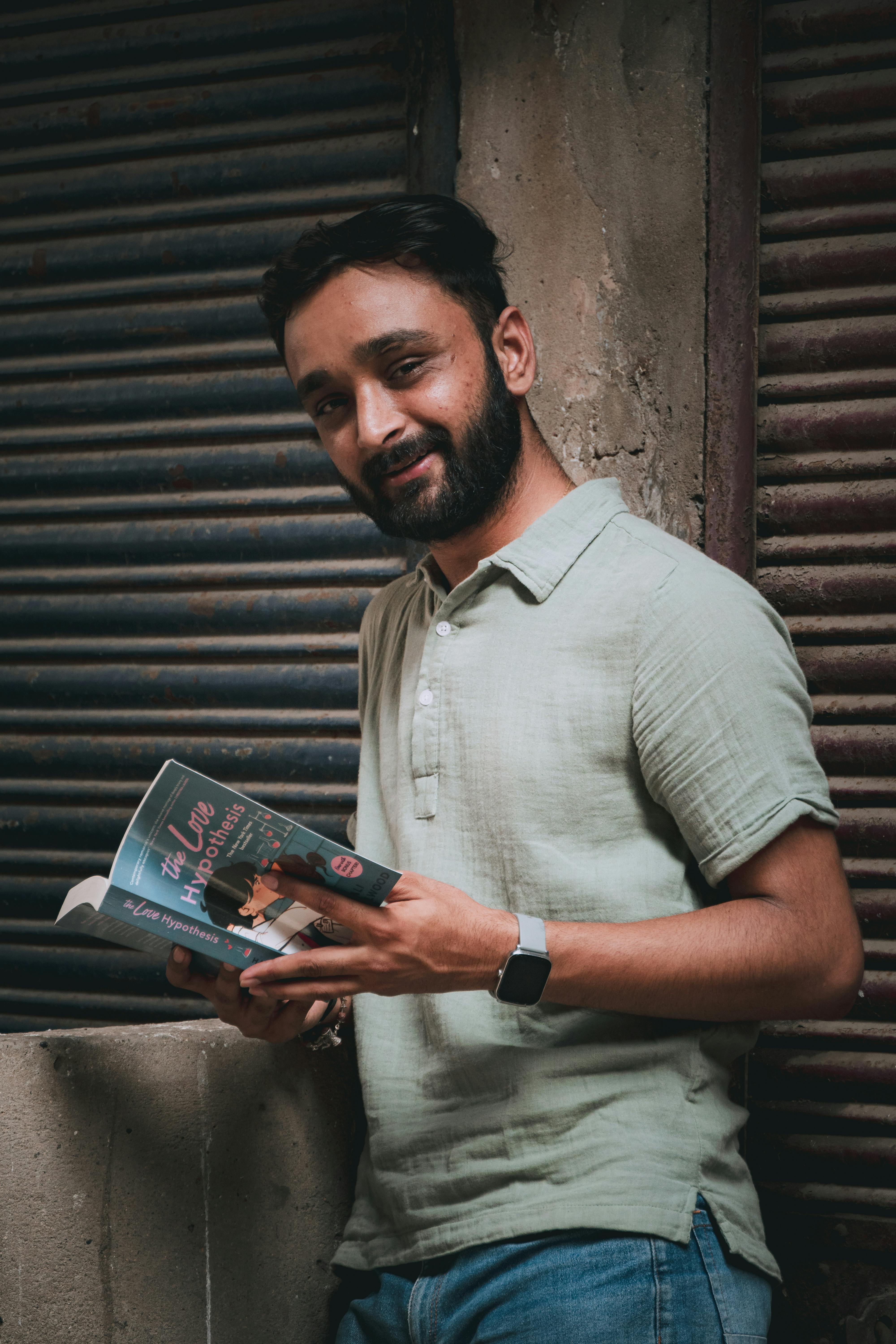 Portrait of Man Reading a Book on a Street · Free Stock Photo