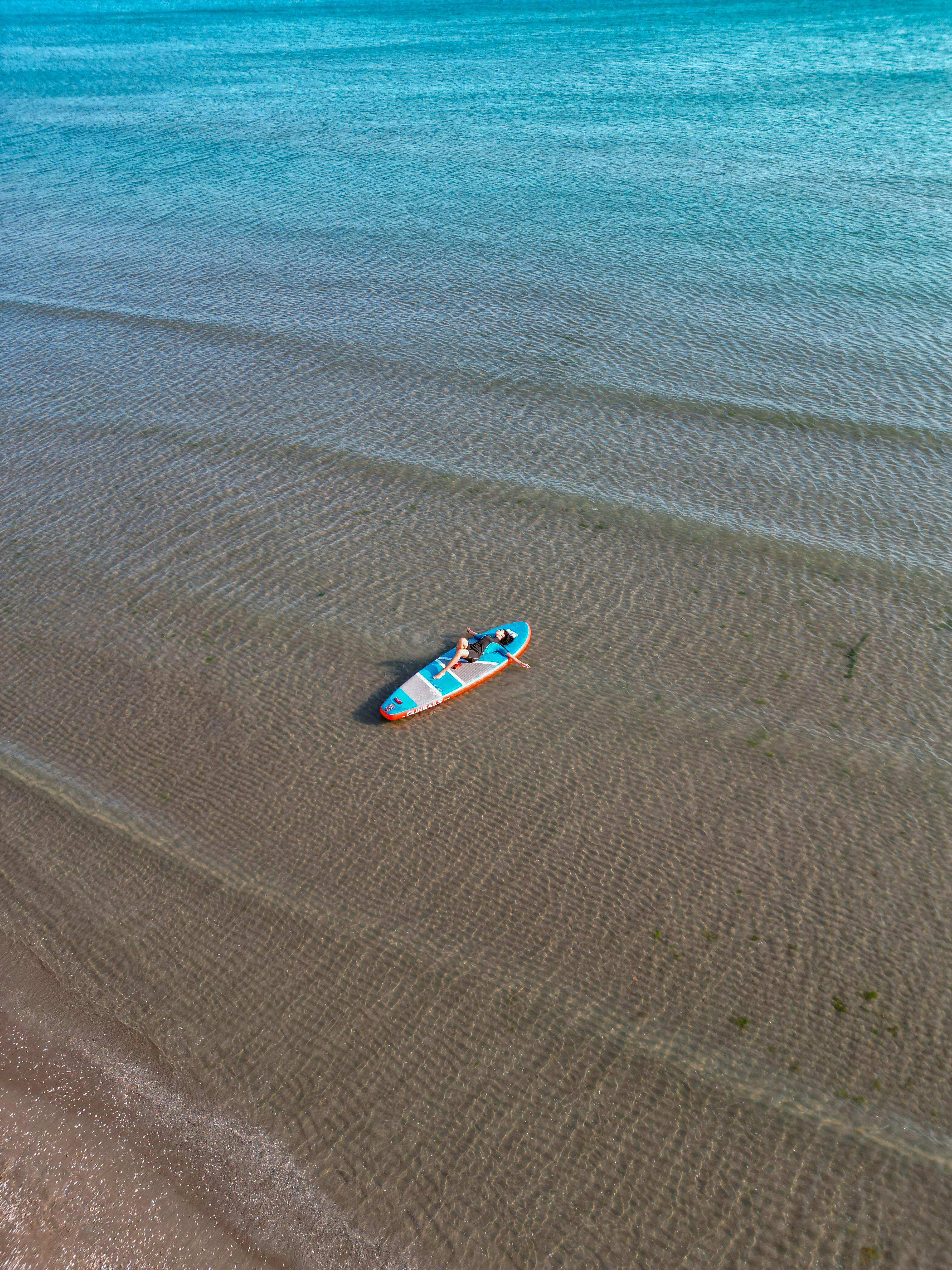 Woman Lying on Paddleboard · Free Stock Photo