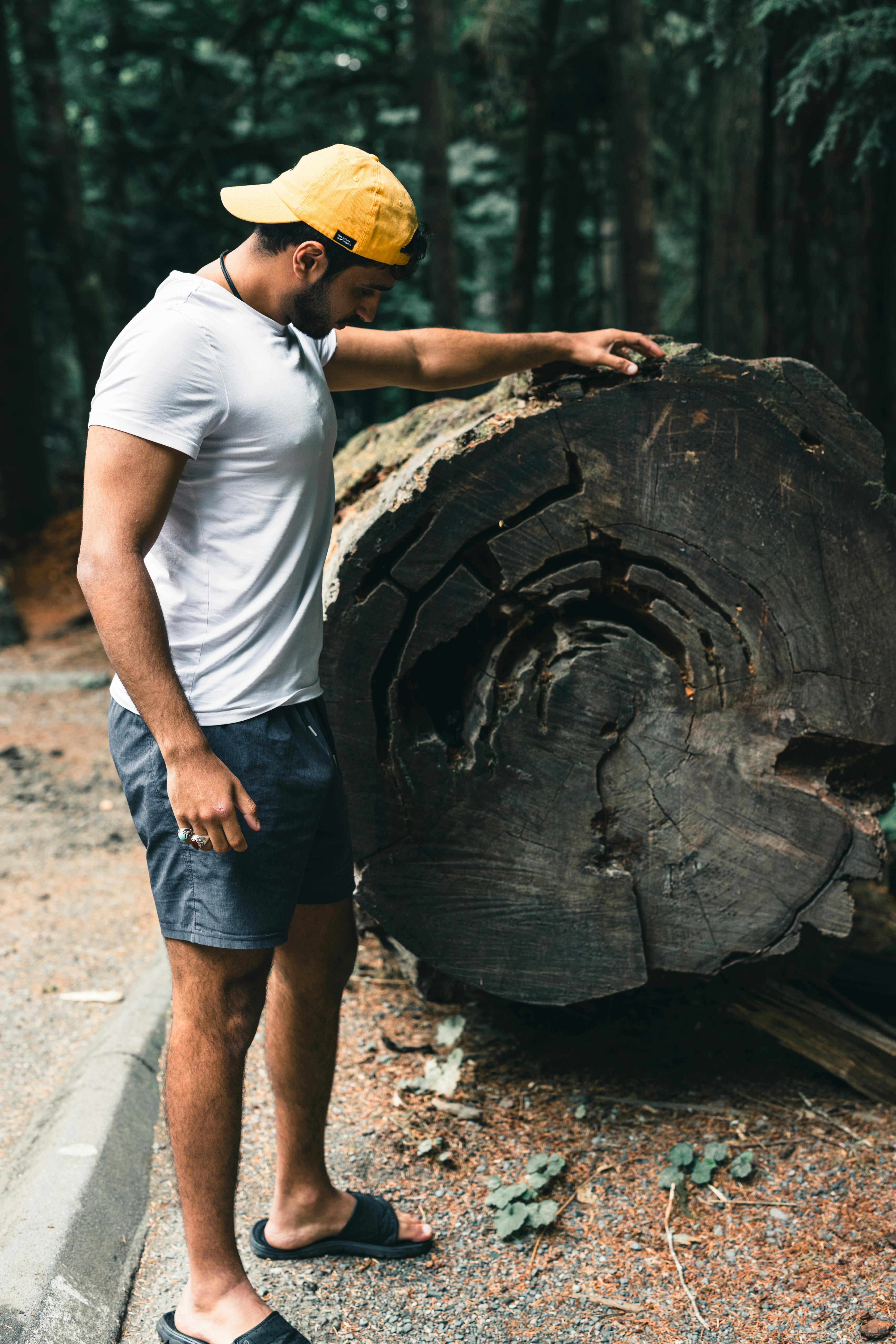Man with a Tree Trunk in a Forest · Free Stock Photo