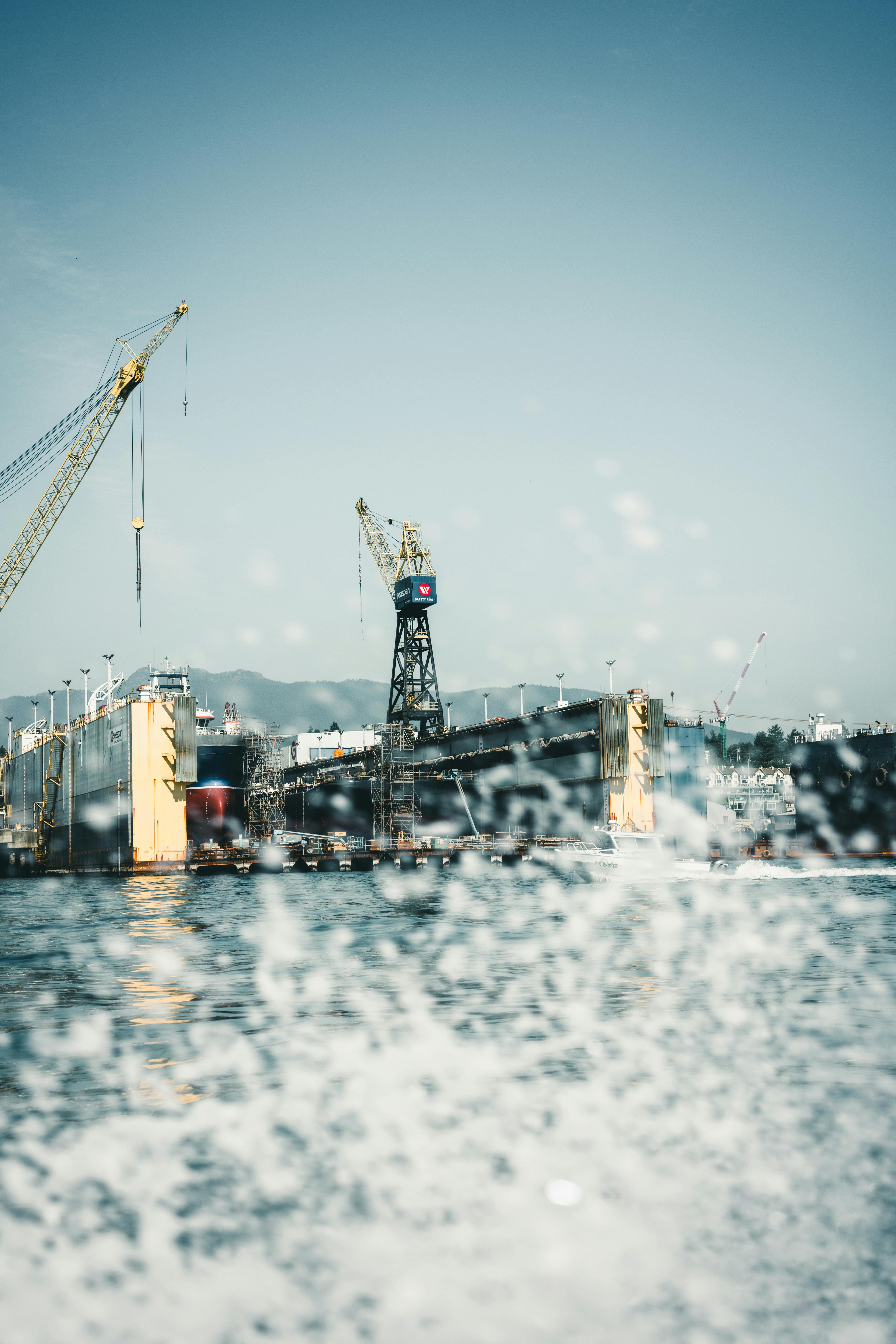 Red Concrete Building Near the Ocean With Boat during Daytime · Free ...