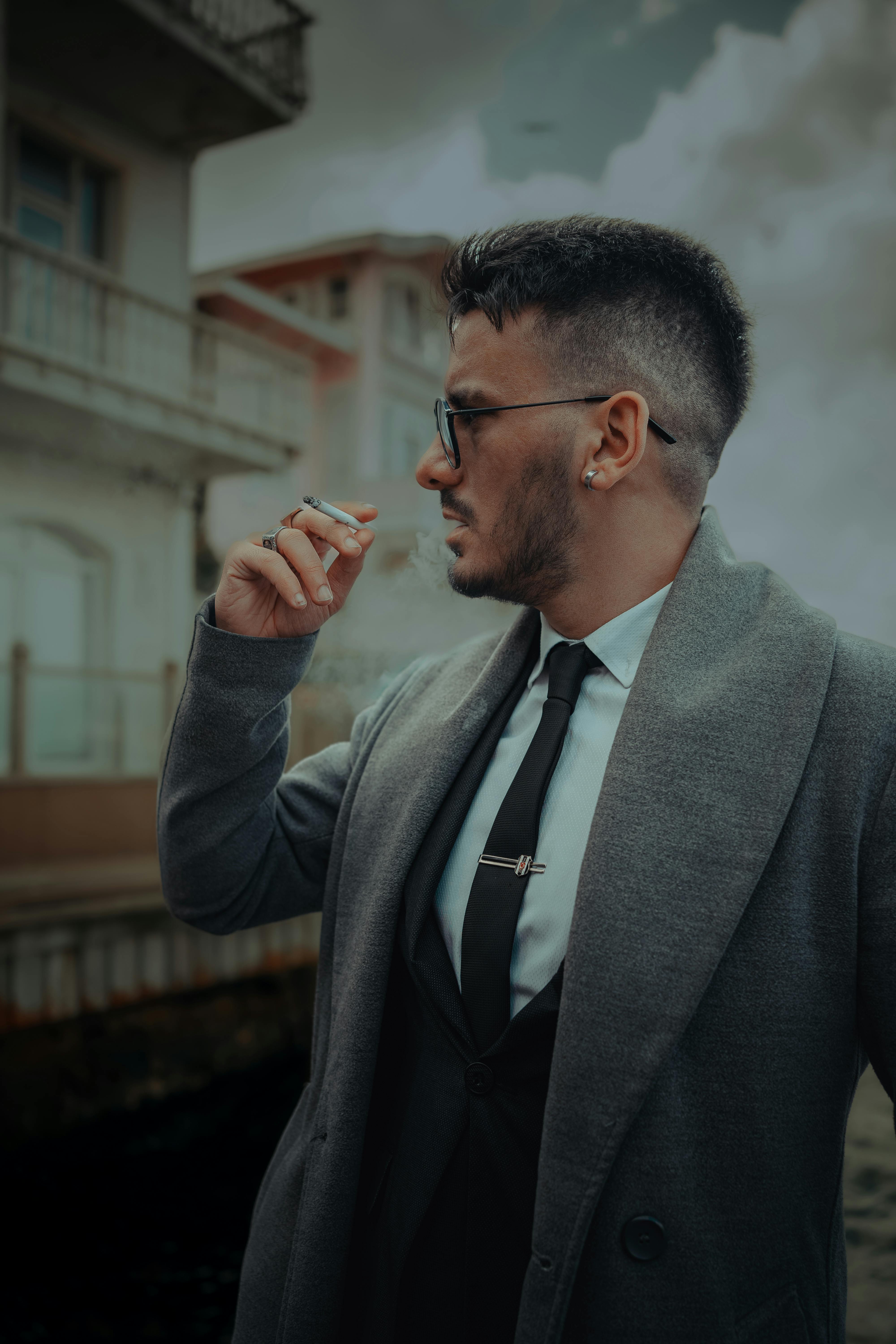 Serious Businessman Smoking a Cigarette in the City · Free Stock Photo