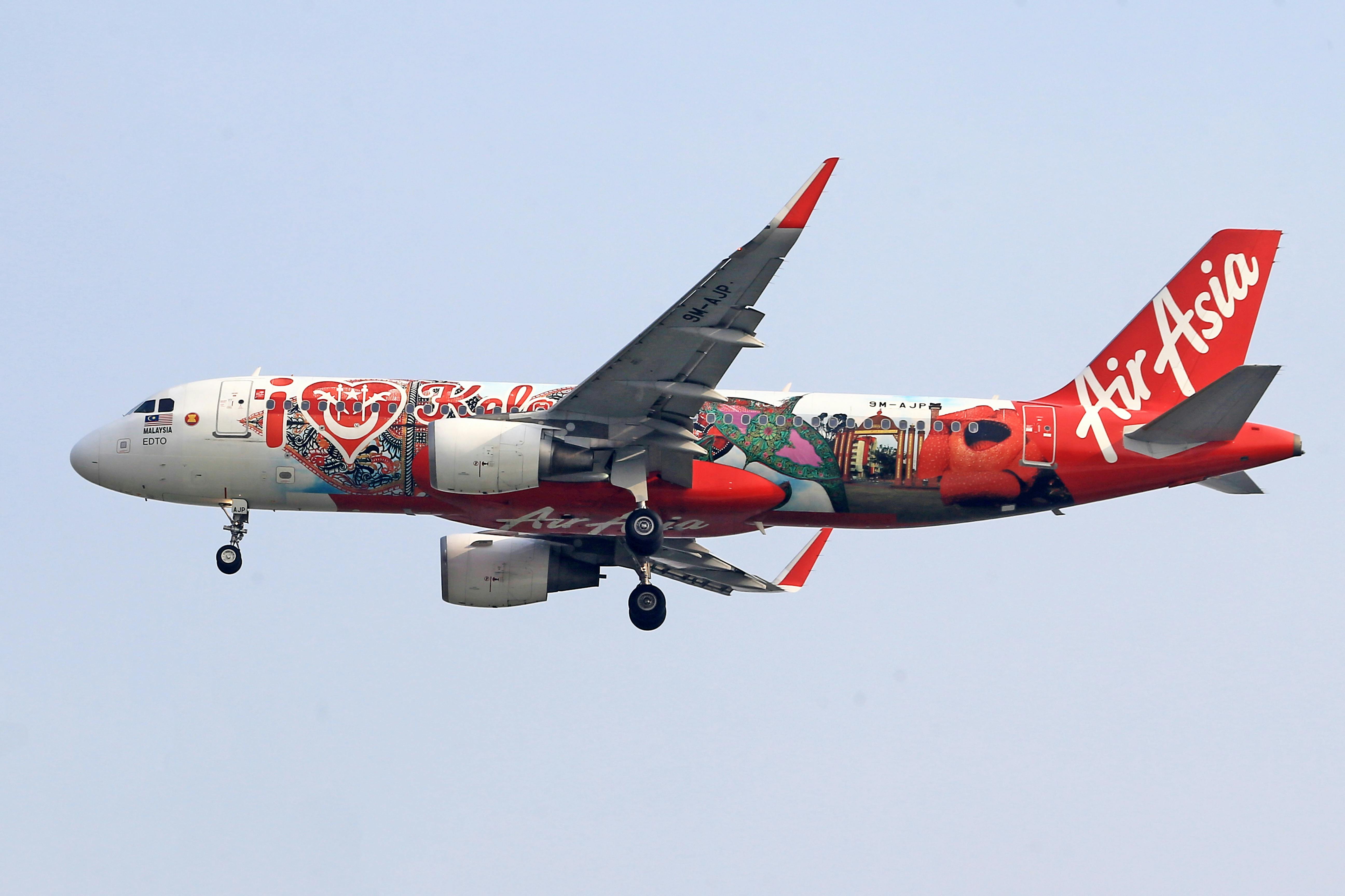 An AirAsia Airbus Flying against Clear Sky · Free Stock Photo