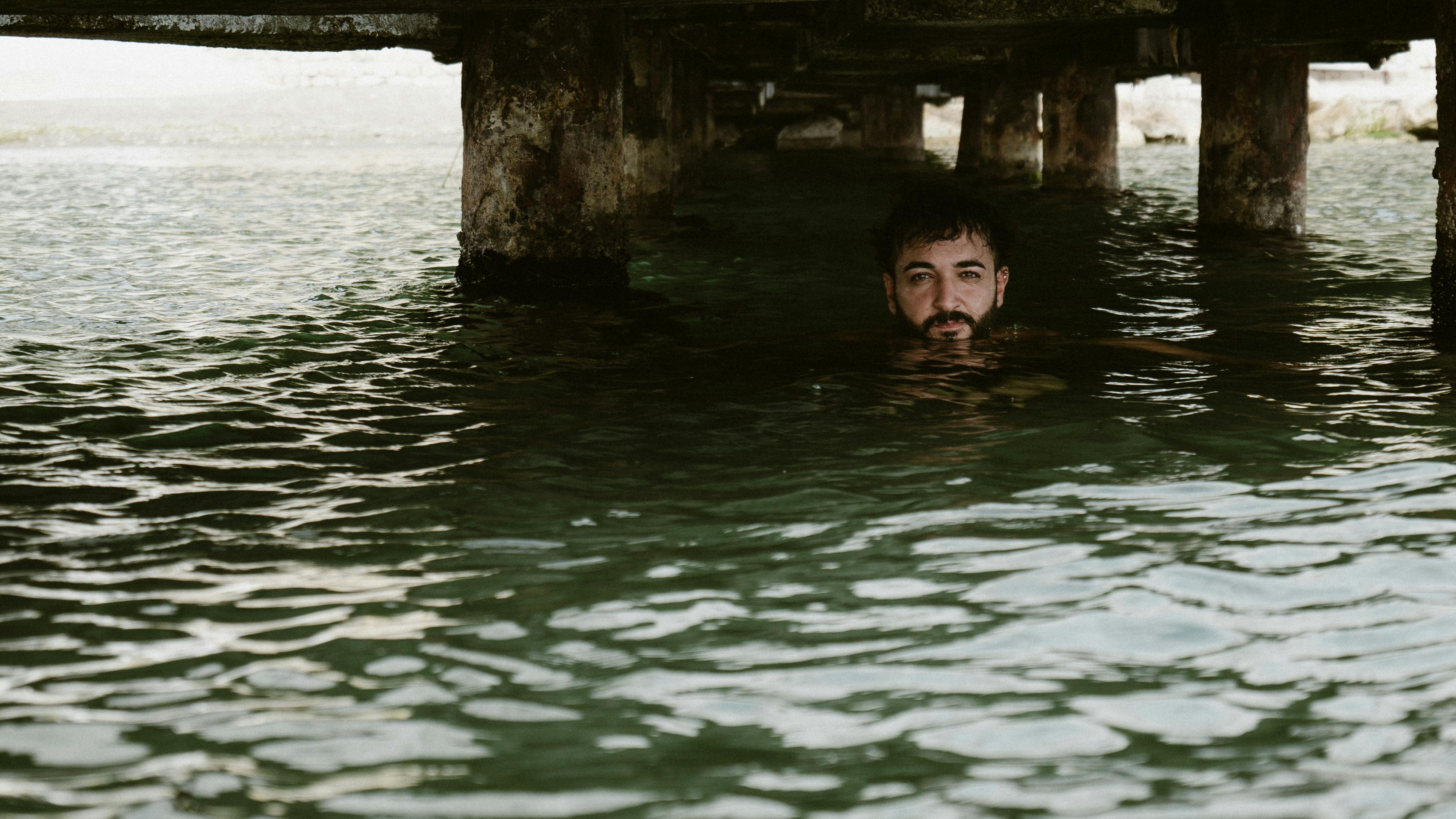Man Head over Water under Bridge · Free Stock Photo