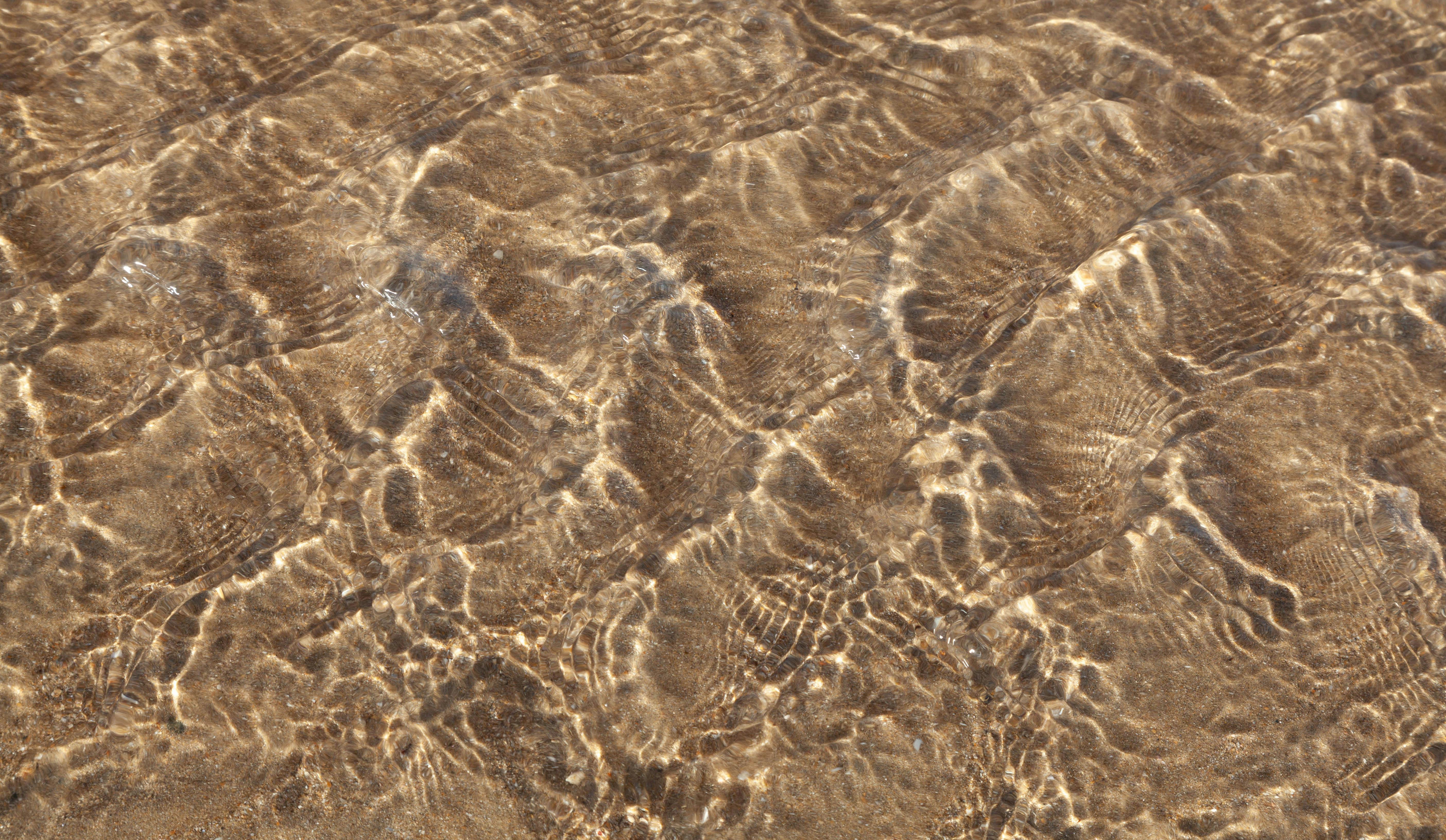 Shallow Sea Water Undulating over Beach Sand · Free Stock Photo