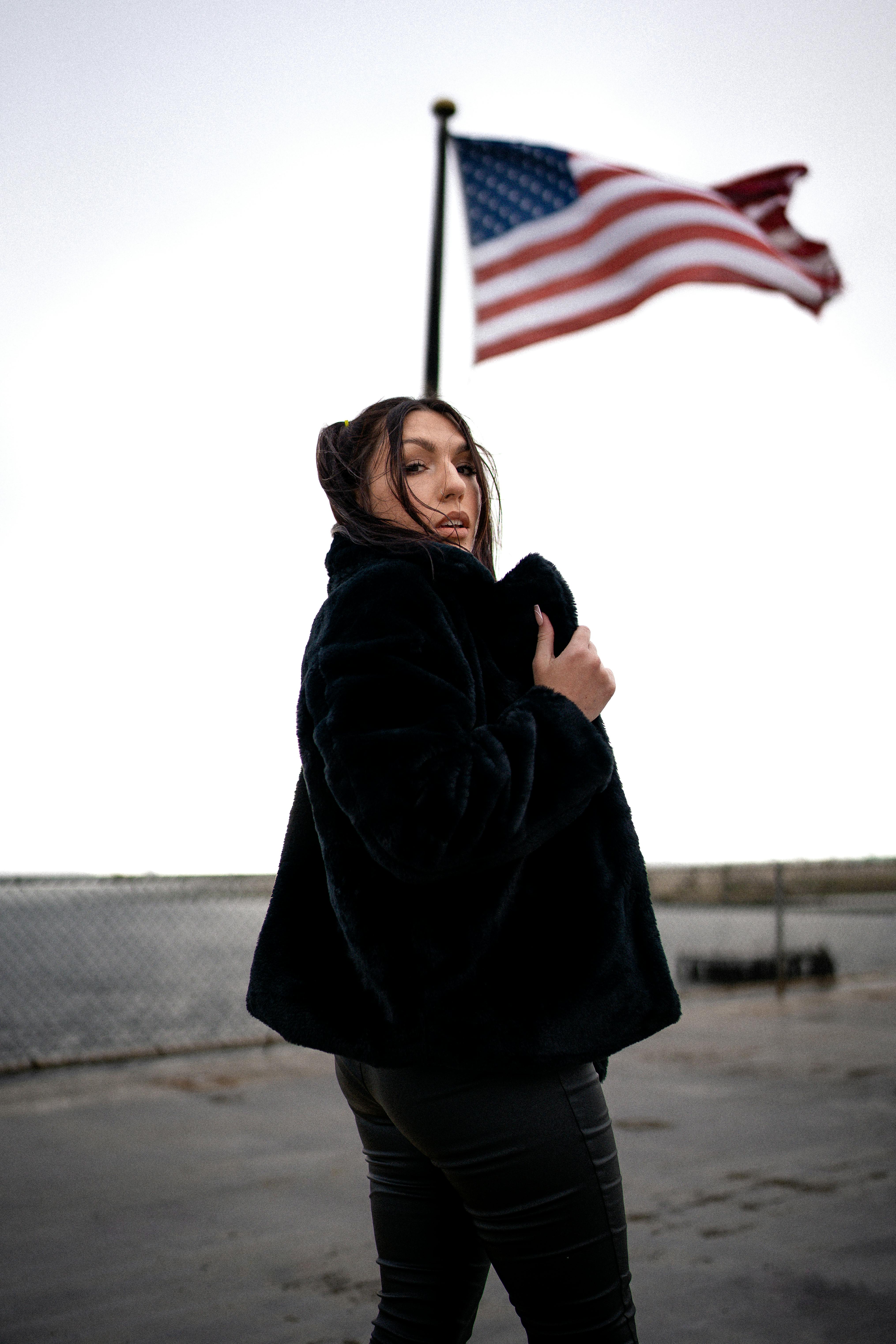 Woman Posing with American Flag behind · Free Stock Photo