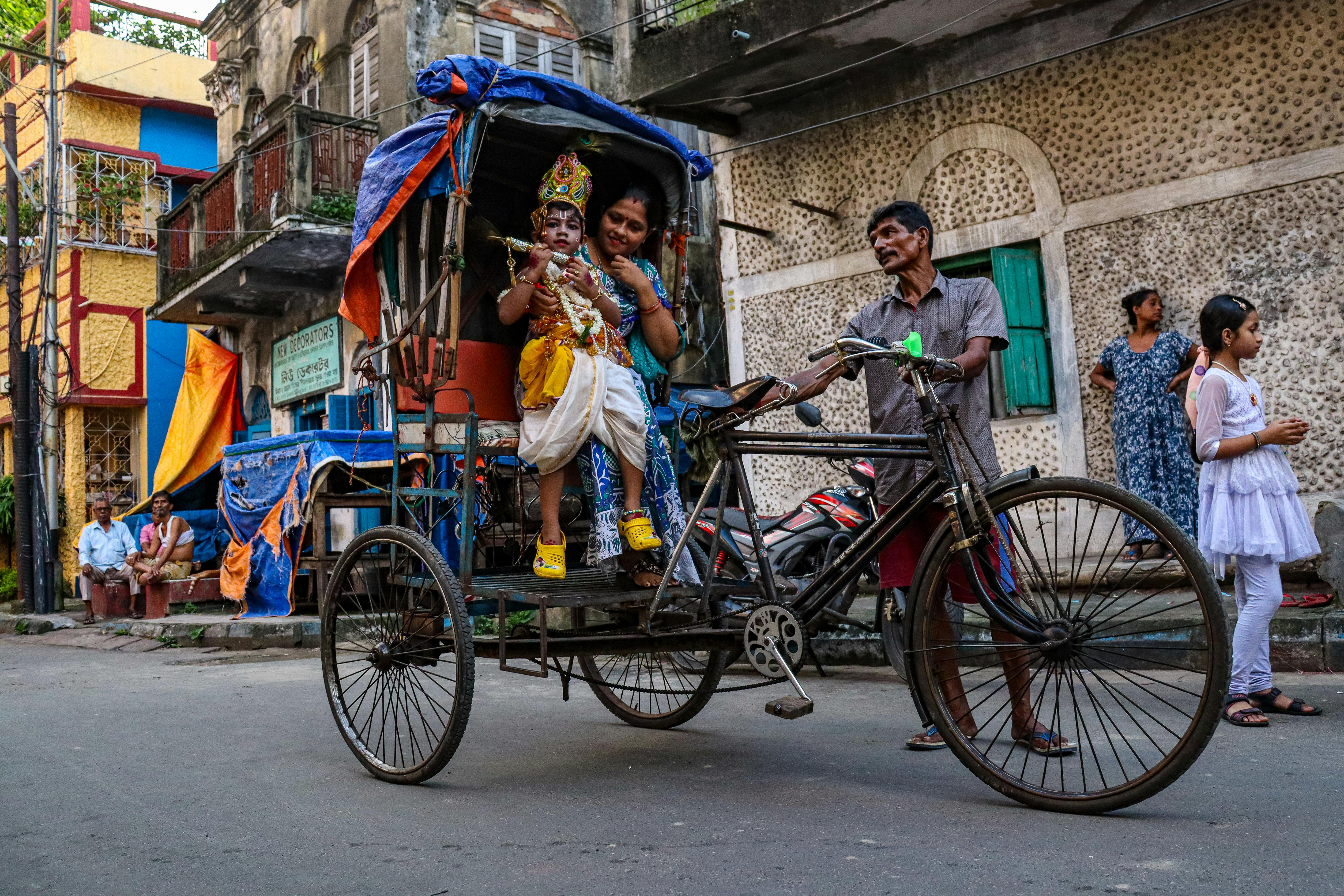 Child Wearing Traditional Costume Sitting in Rickshaw · Free Stock Photo