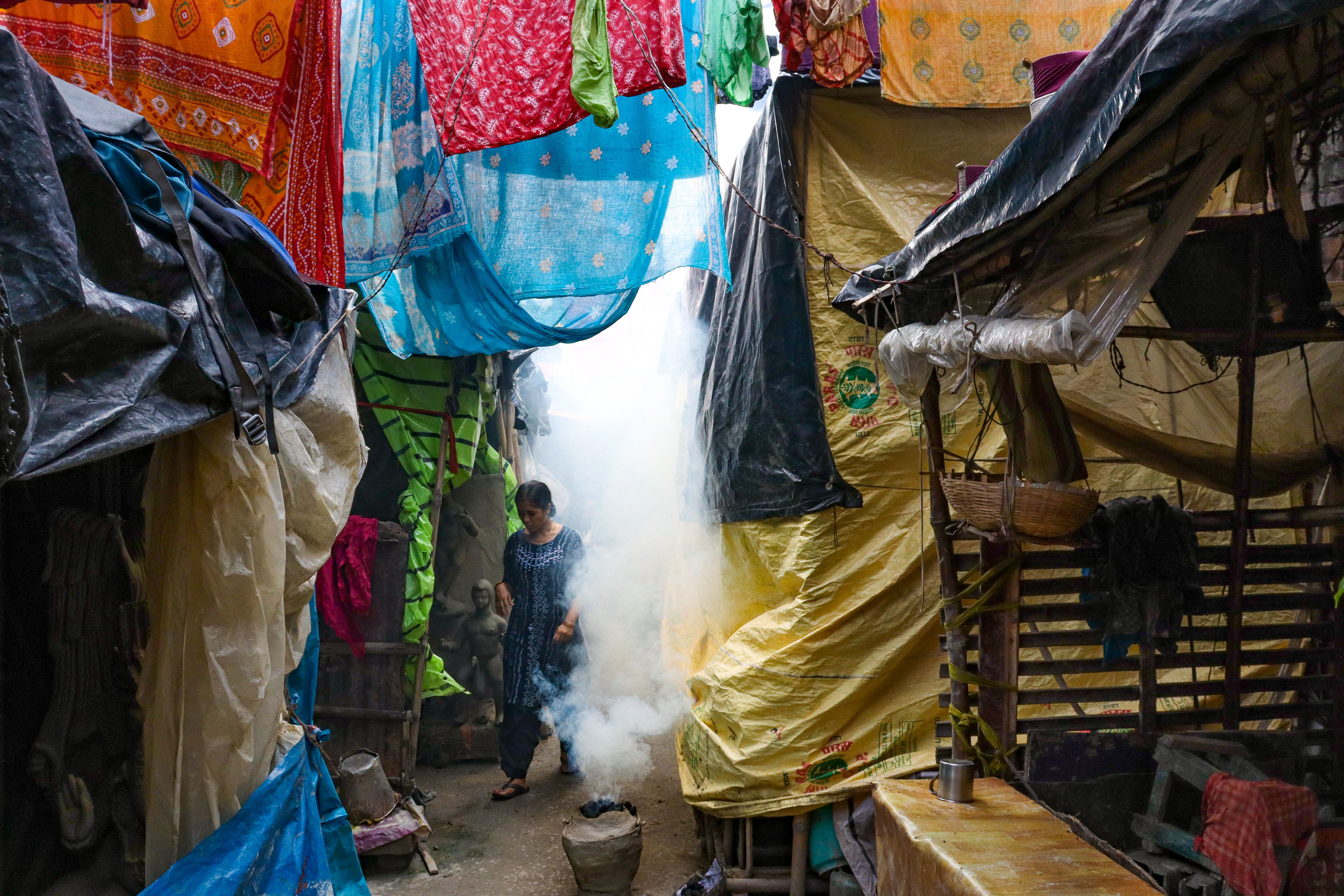 Woman Walking in Alley with Fabrics and Cloths · Free Stock Photo