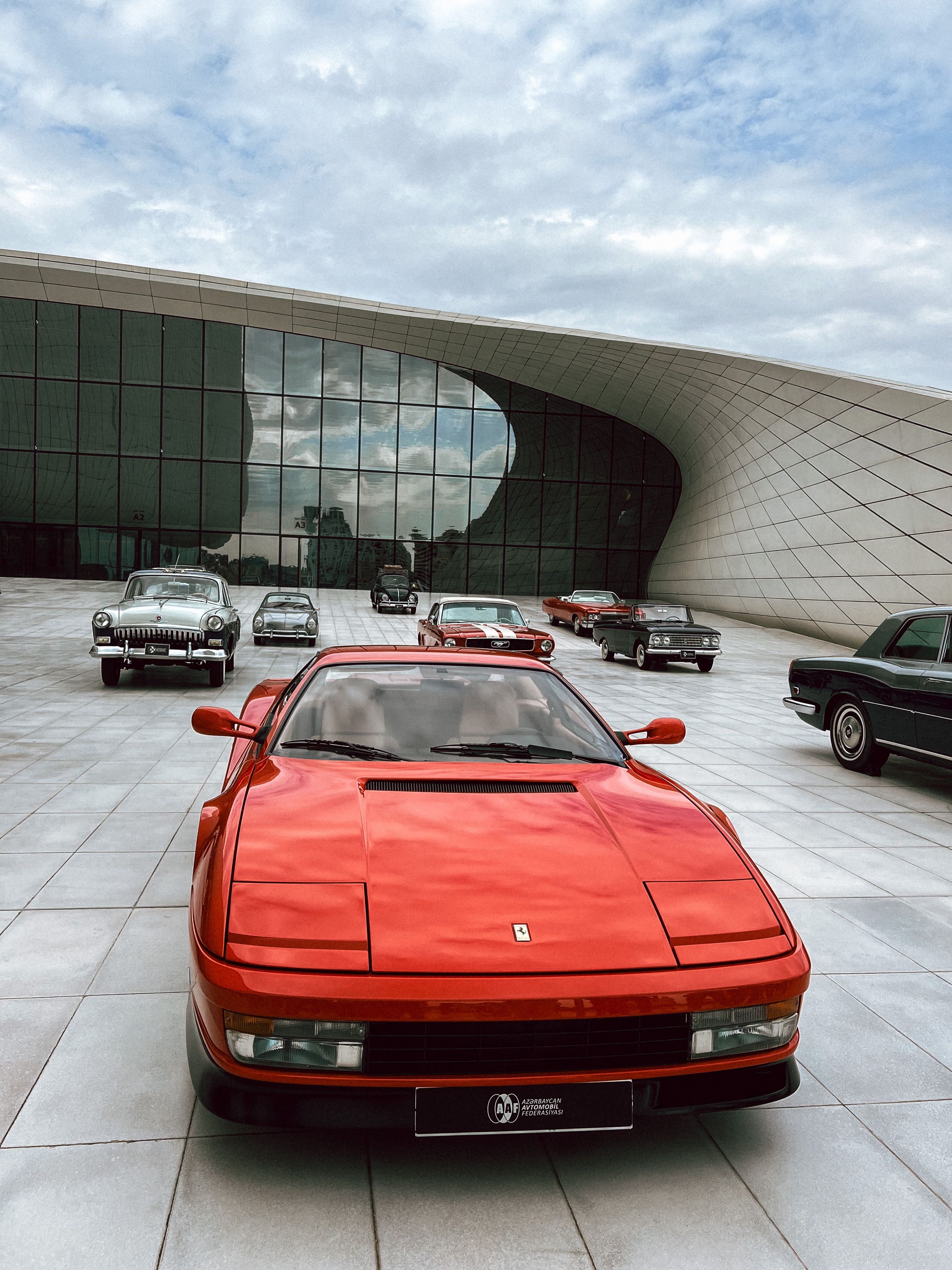 Exhibition of Cars in front of Modern Architecture · Free Stock Photo