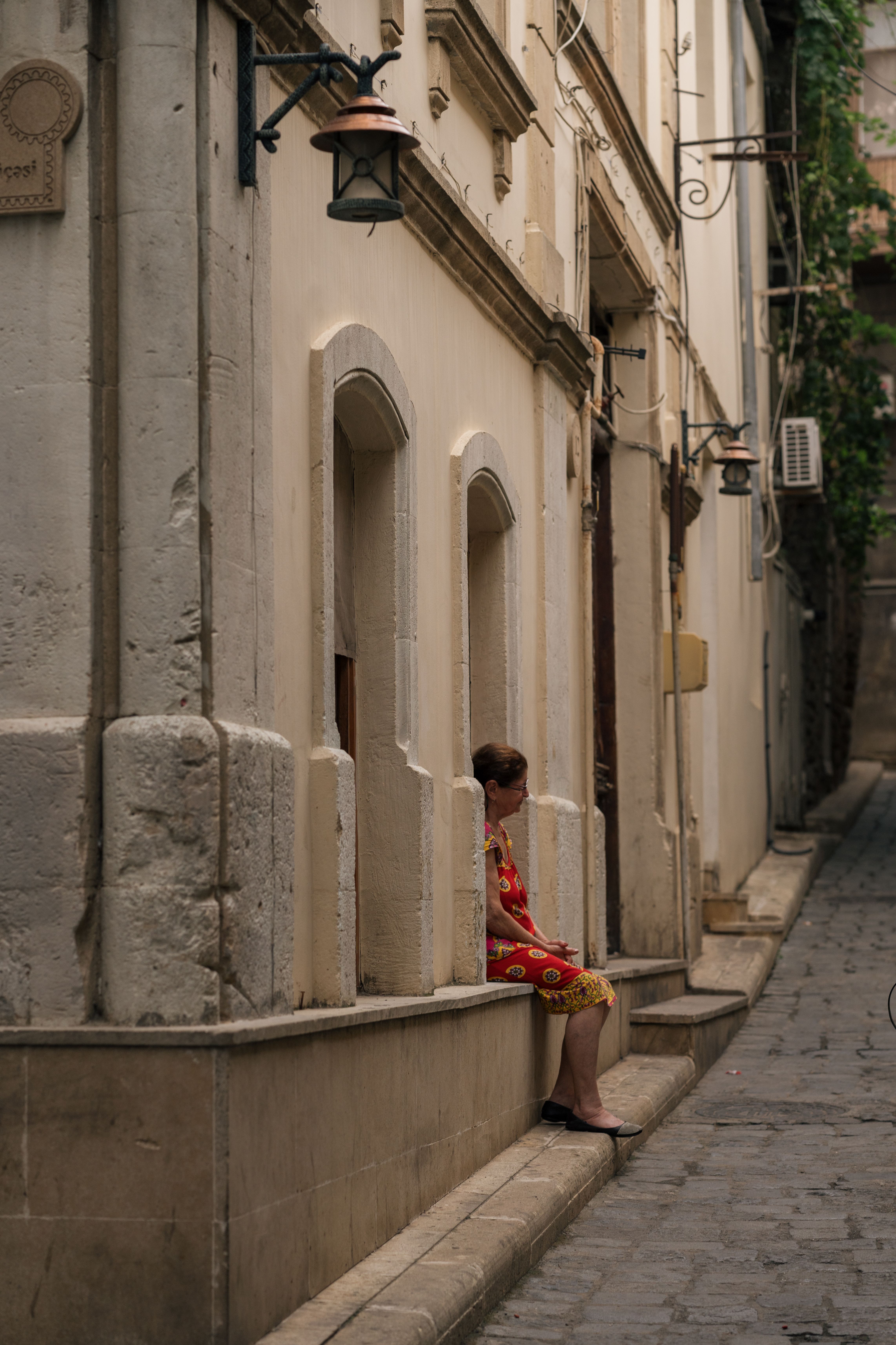 Woman Sitting on Building Wall · Free Stock Photo