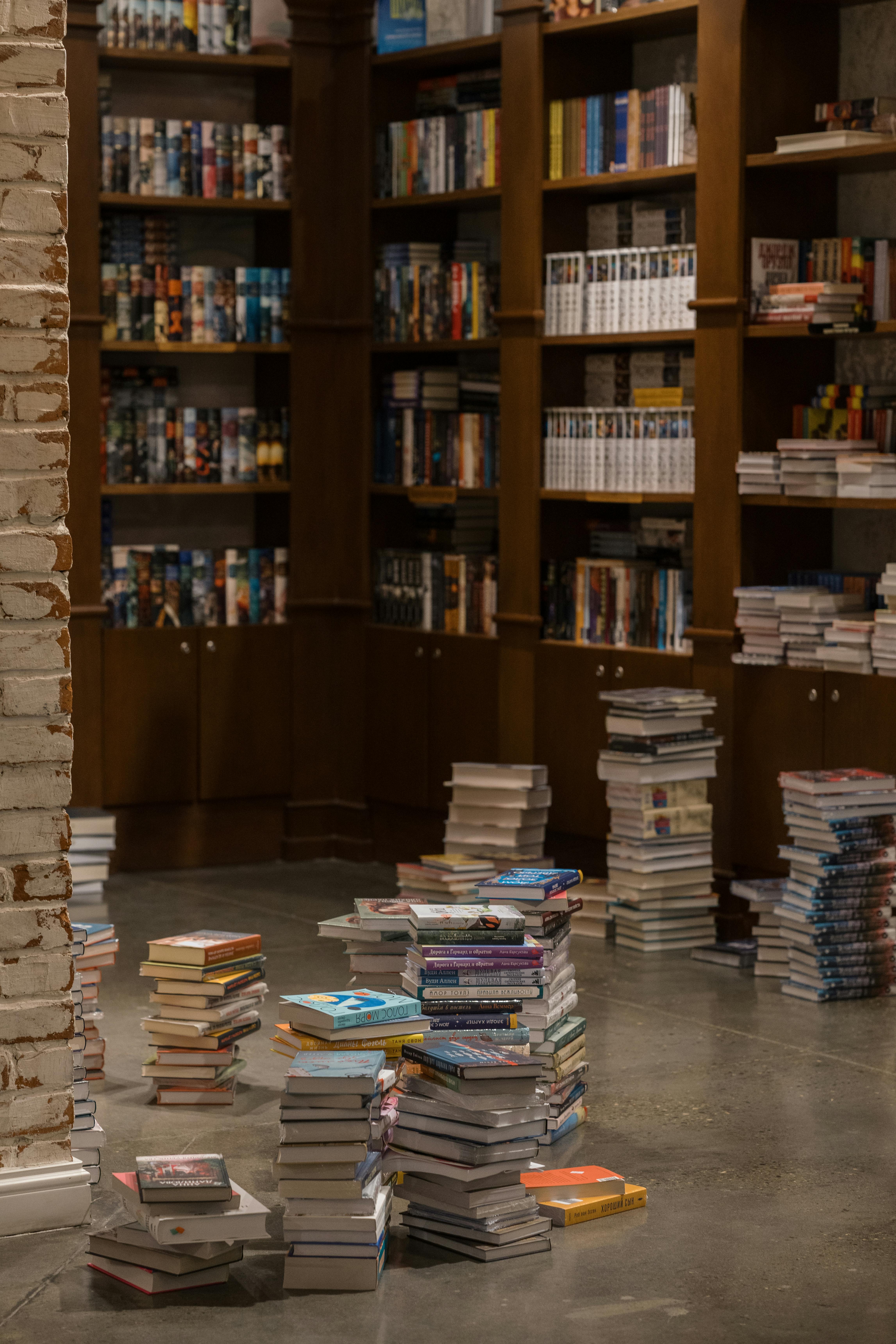 Books on Floor and Shelves in Library · Free Stock Photo