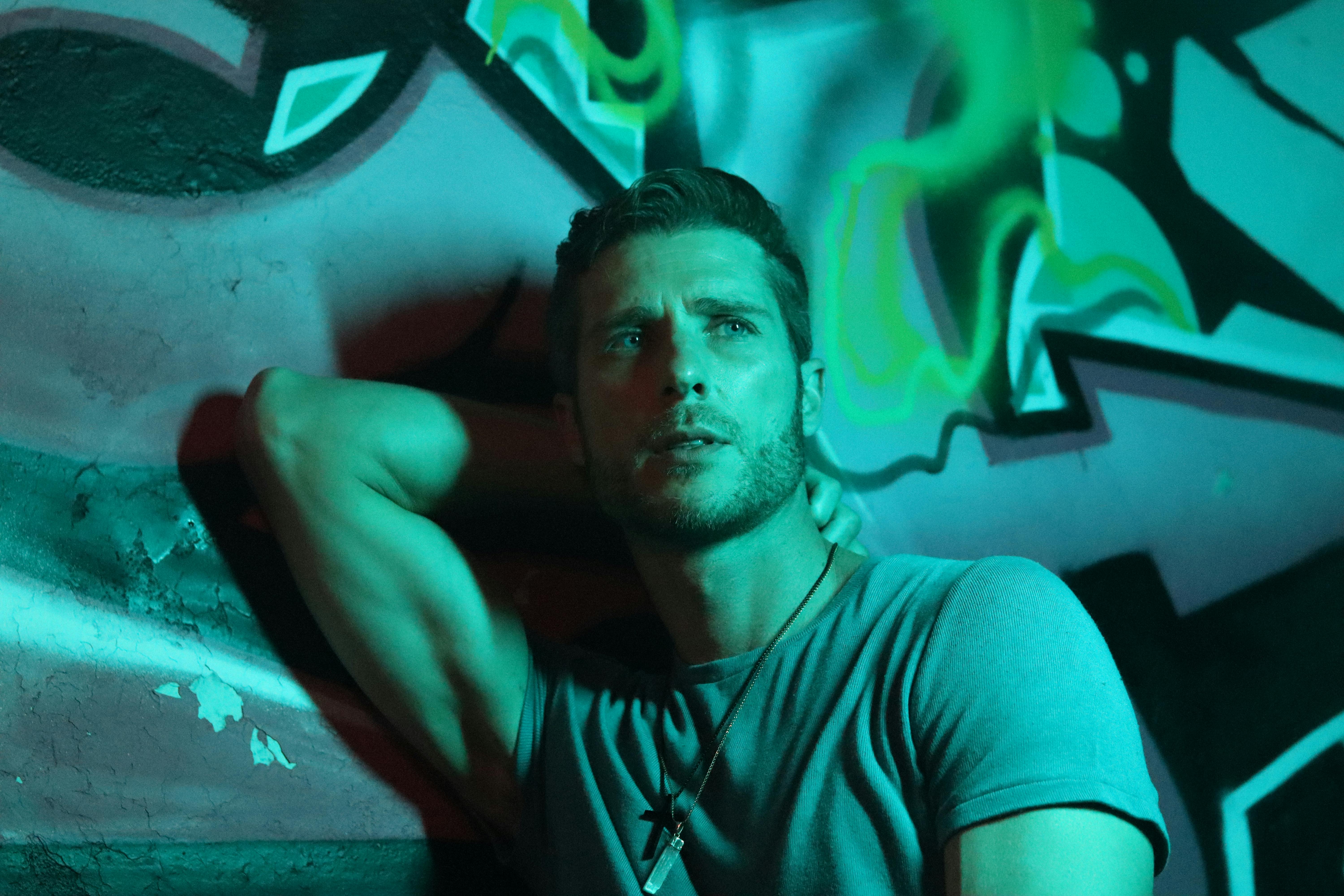 Muscular Man Standing Against the Wall · Free Stock Photo