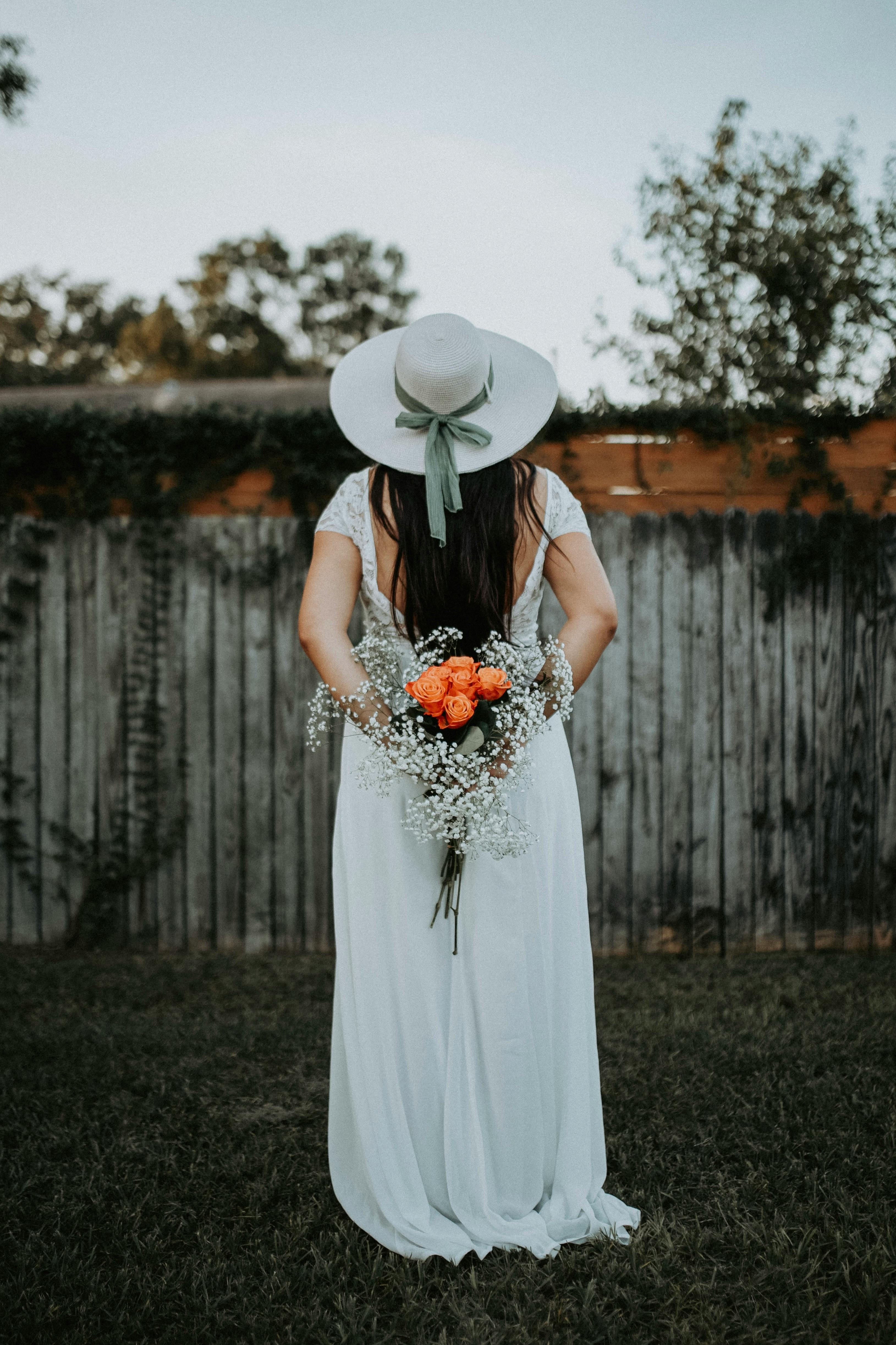 Back View of Bride in Hat and Wedding Dress · Free Stock Photo
