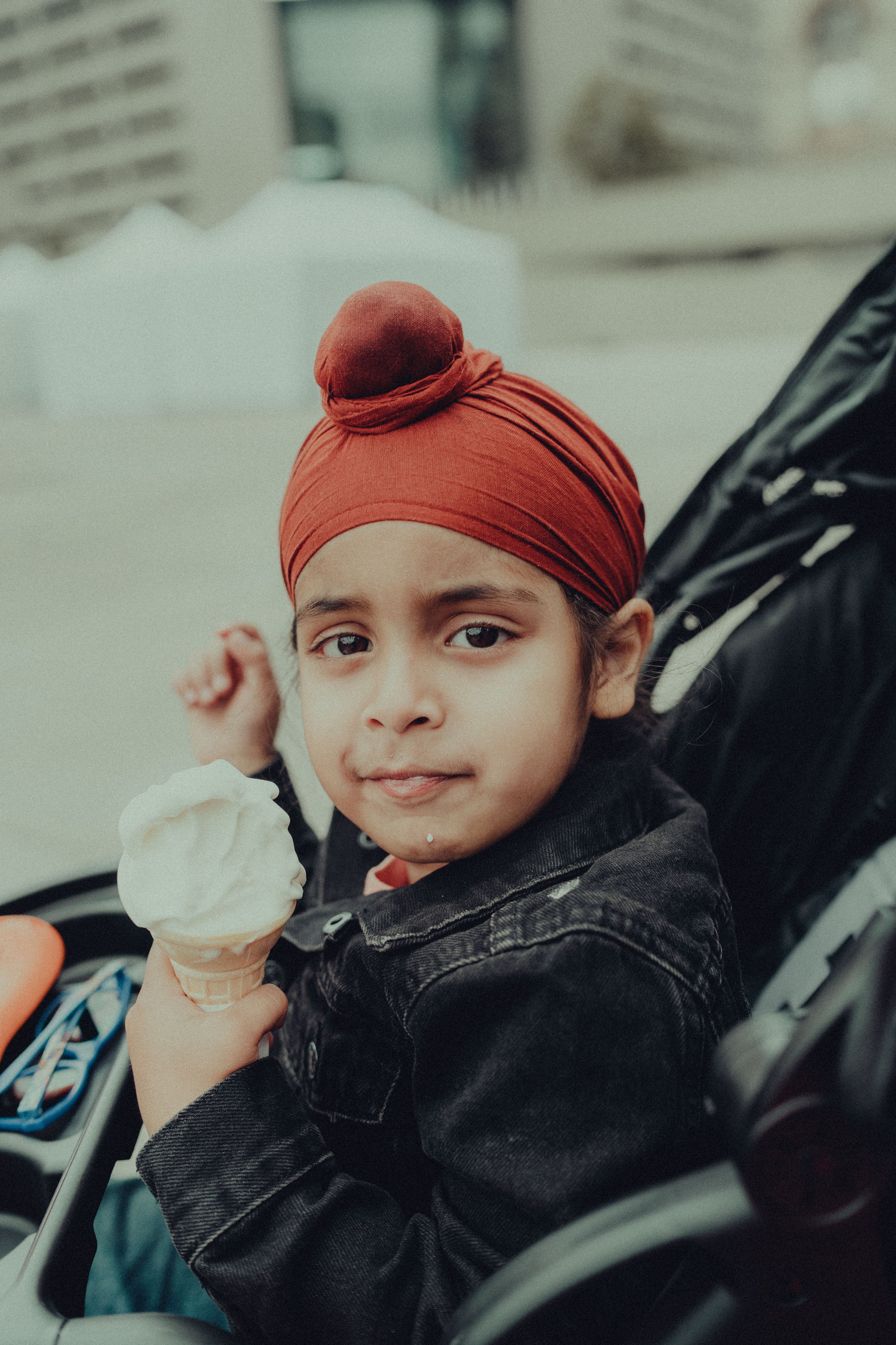 A little boy in a turban eating an ice cream cone · Free Stock Photo