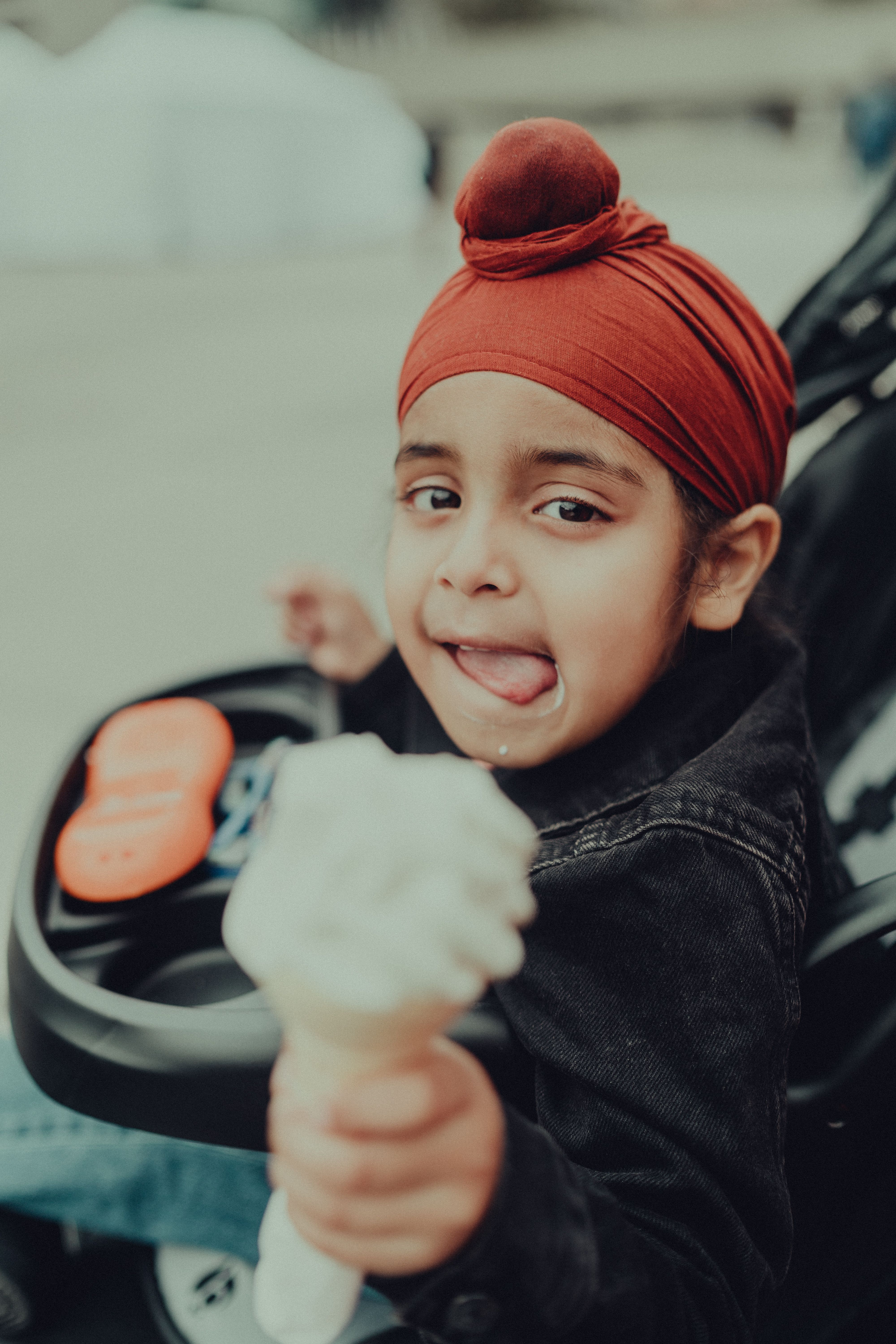 A little girl in a turban holding an ice cream cone · Free Stock Photo