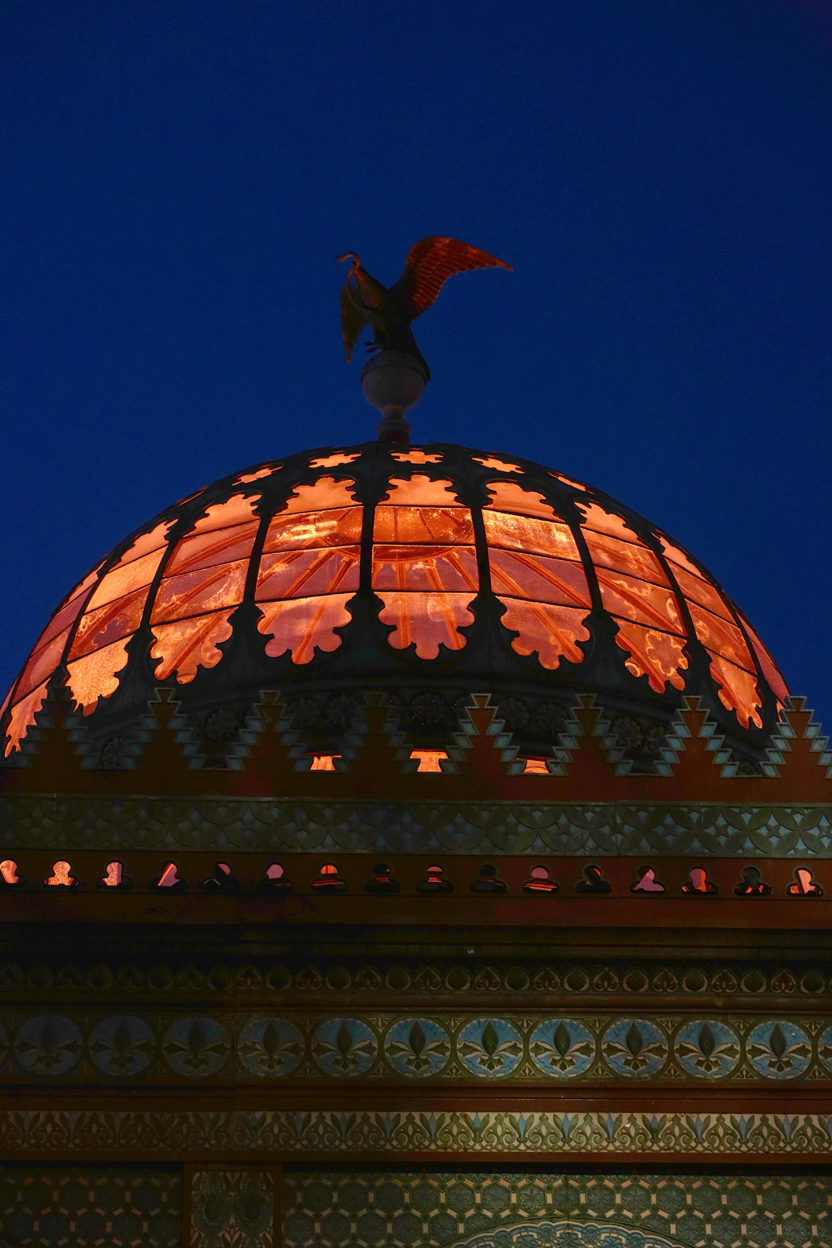 Bird Statue atop Lit up Dome against Night Sky · Free Stock Photo