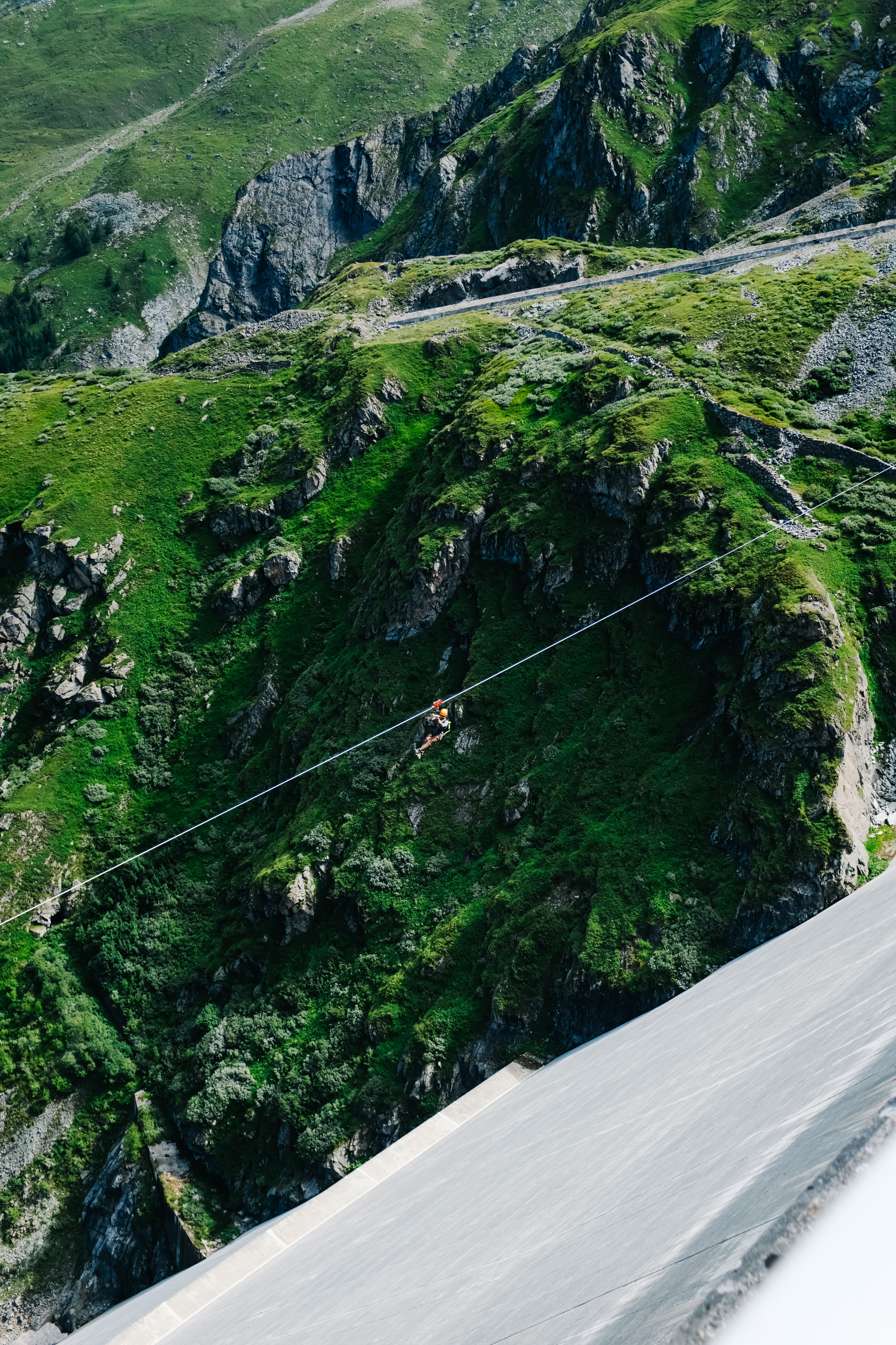 Person Riding Zip Line above Mountain Valley · Free Stock Photo