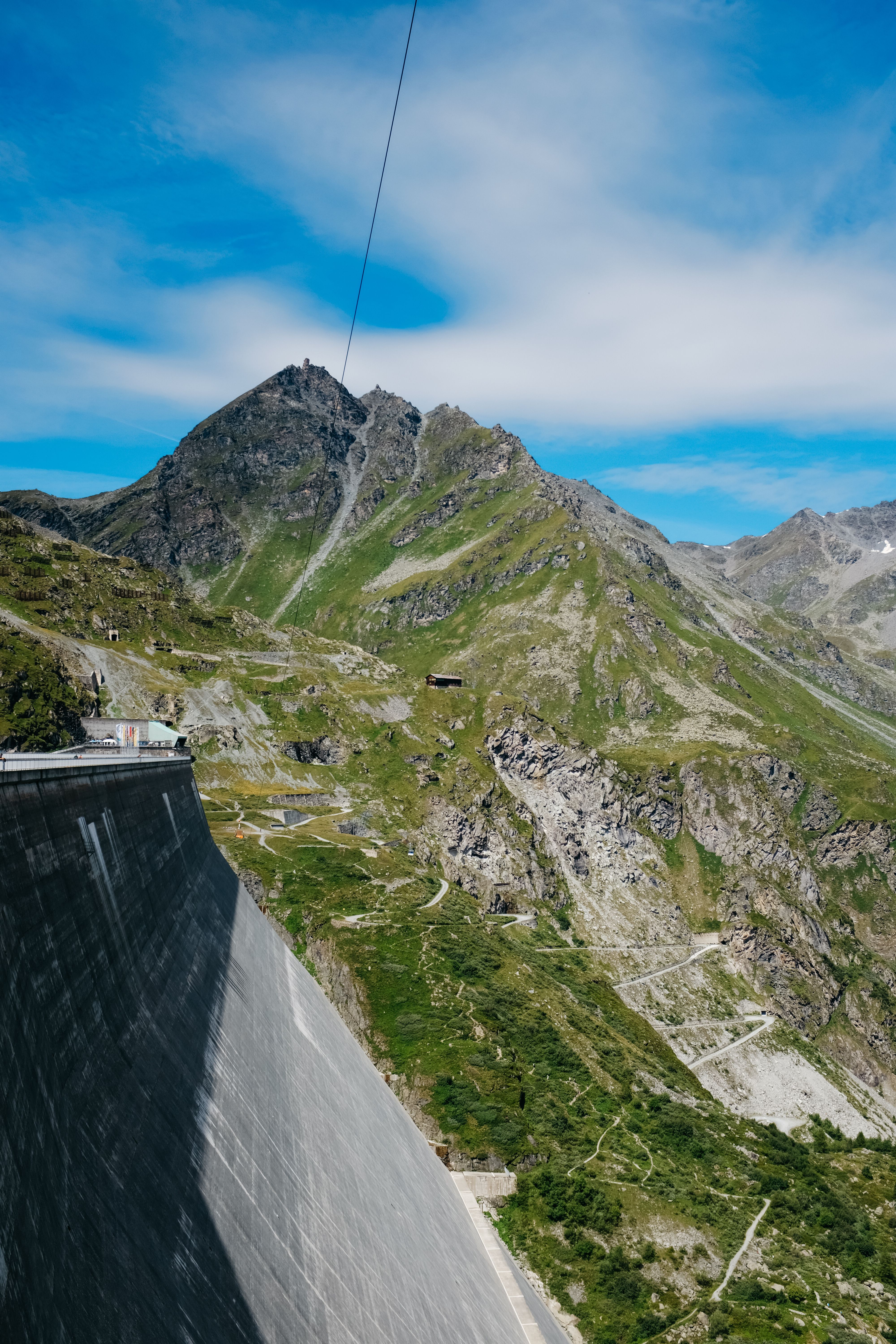 Road and Wall near Slope in Mountains · Free Stock Photo