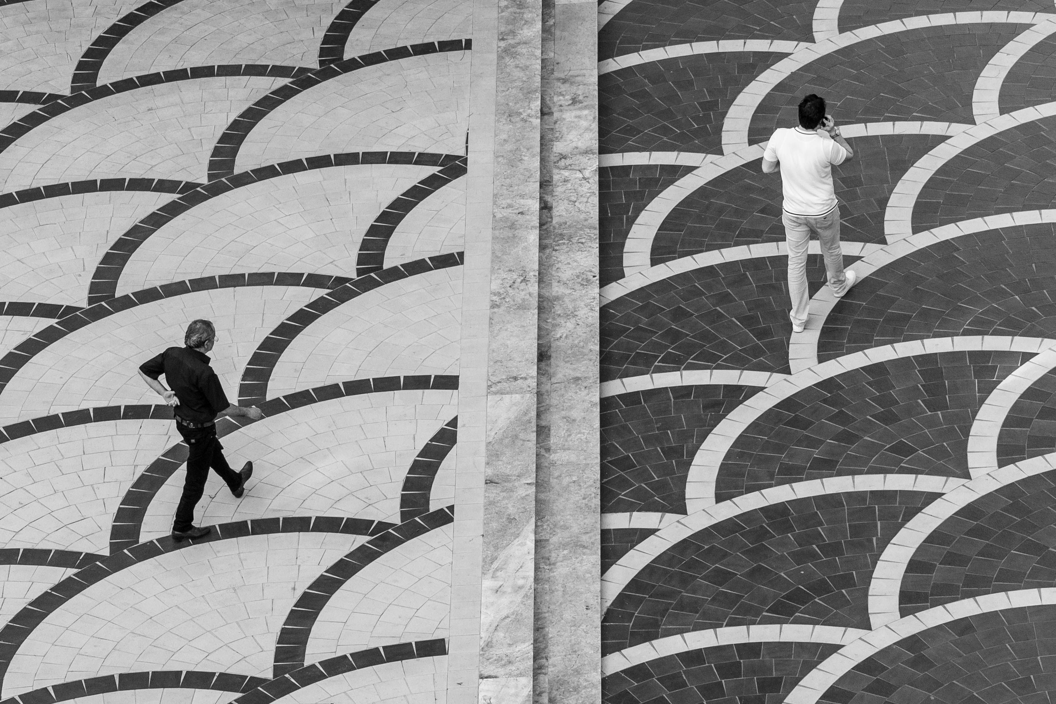 Men Walking on the Sidewalk with a Pattern · Free Stock Photo
