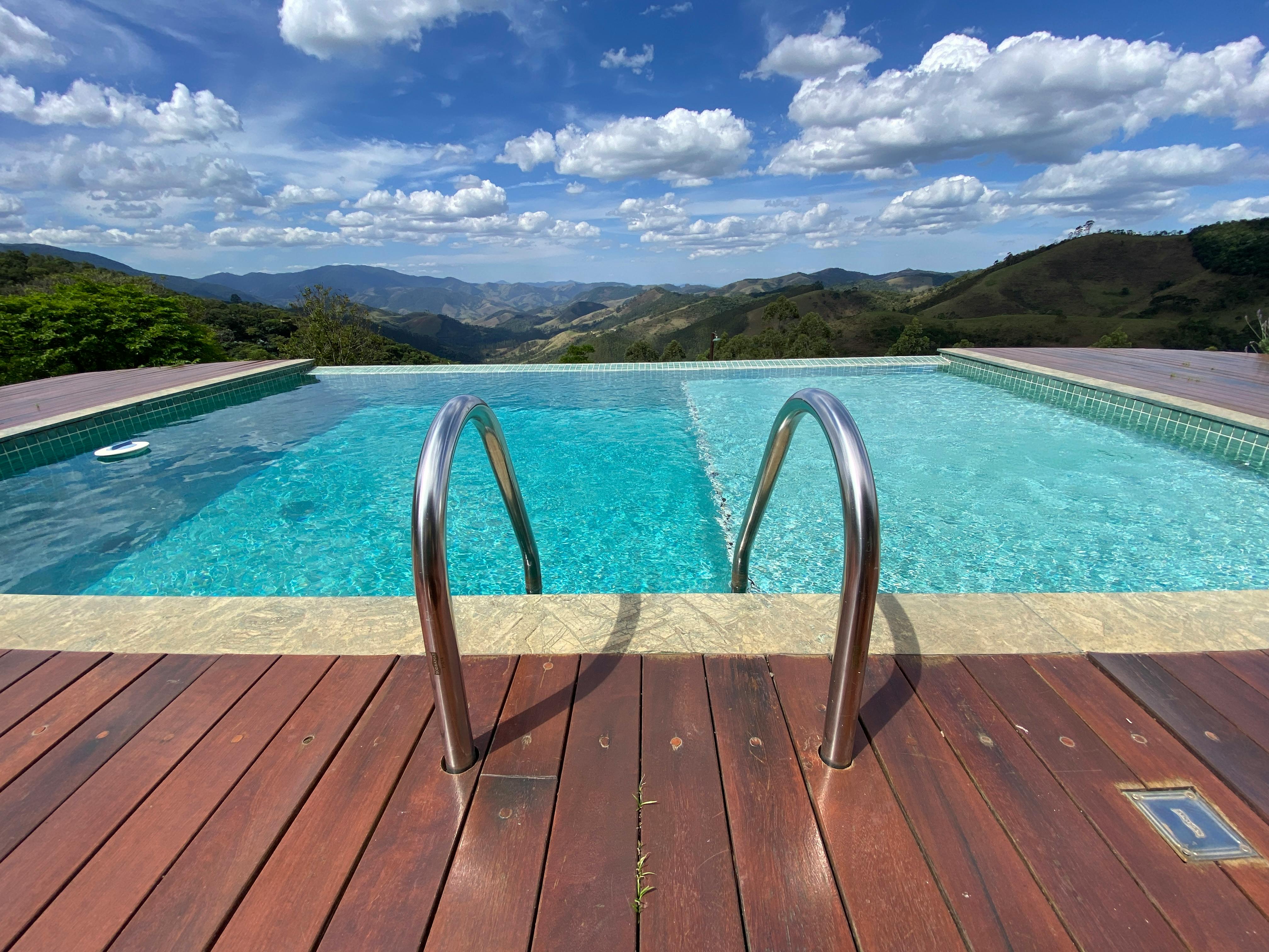 Outdoor Swimming Pool with Distant Mountains · Free Stock Photo