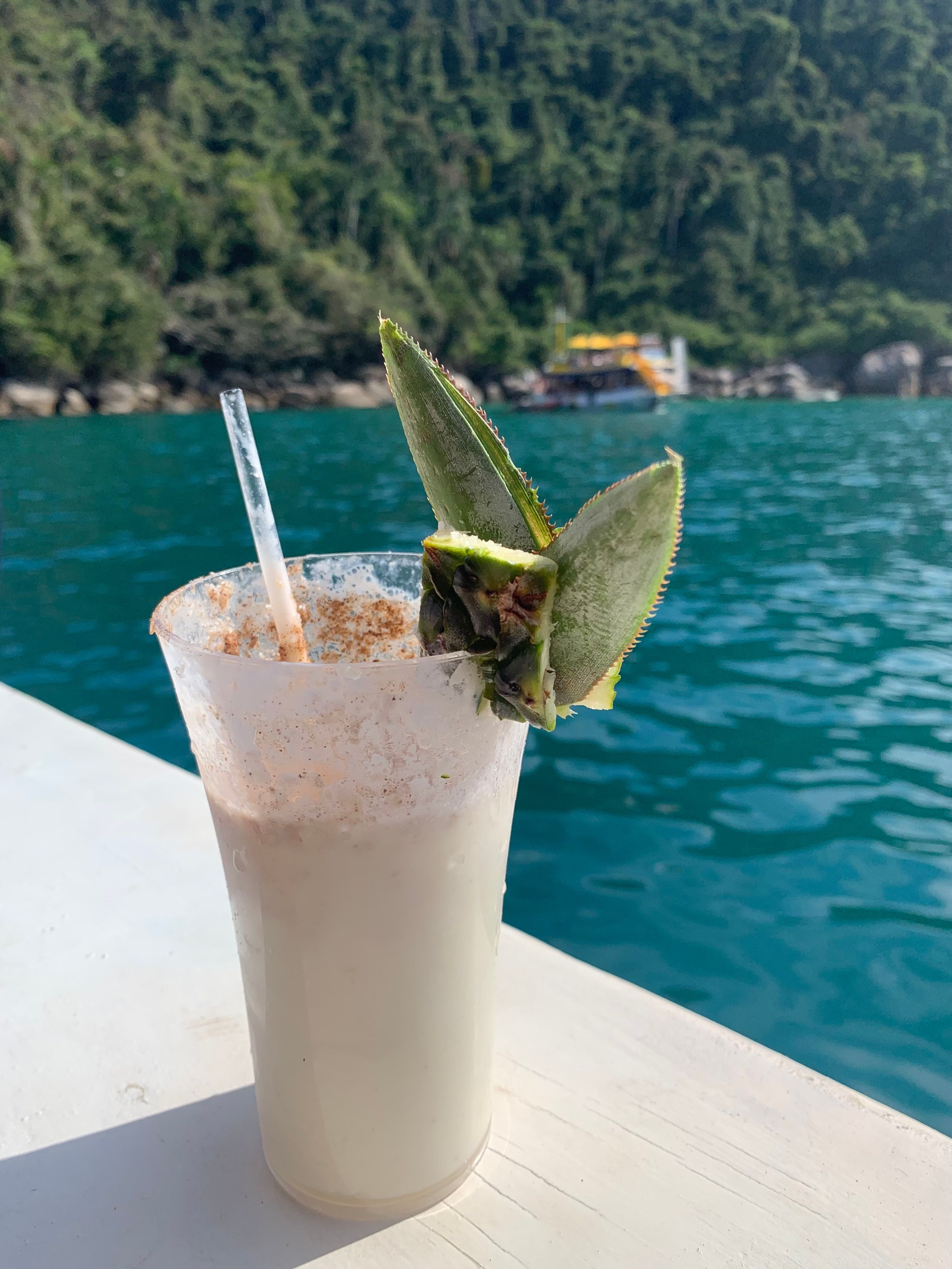 Cocktail Standing on a Ledge by the Sea · Free Stock Photo