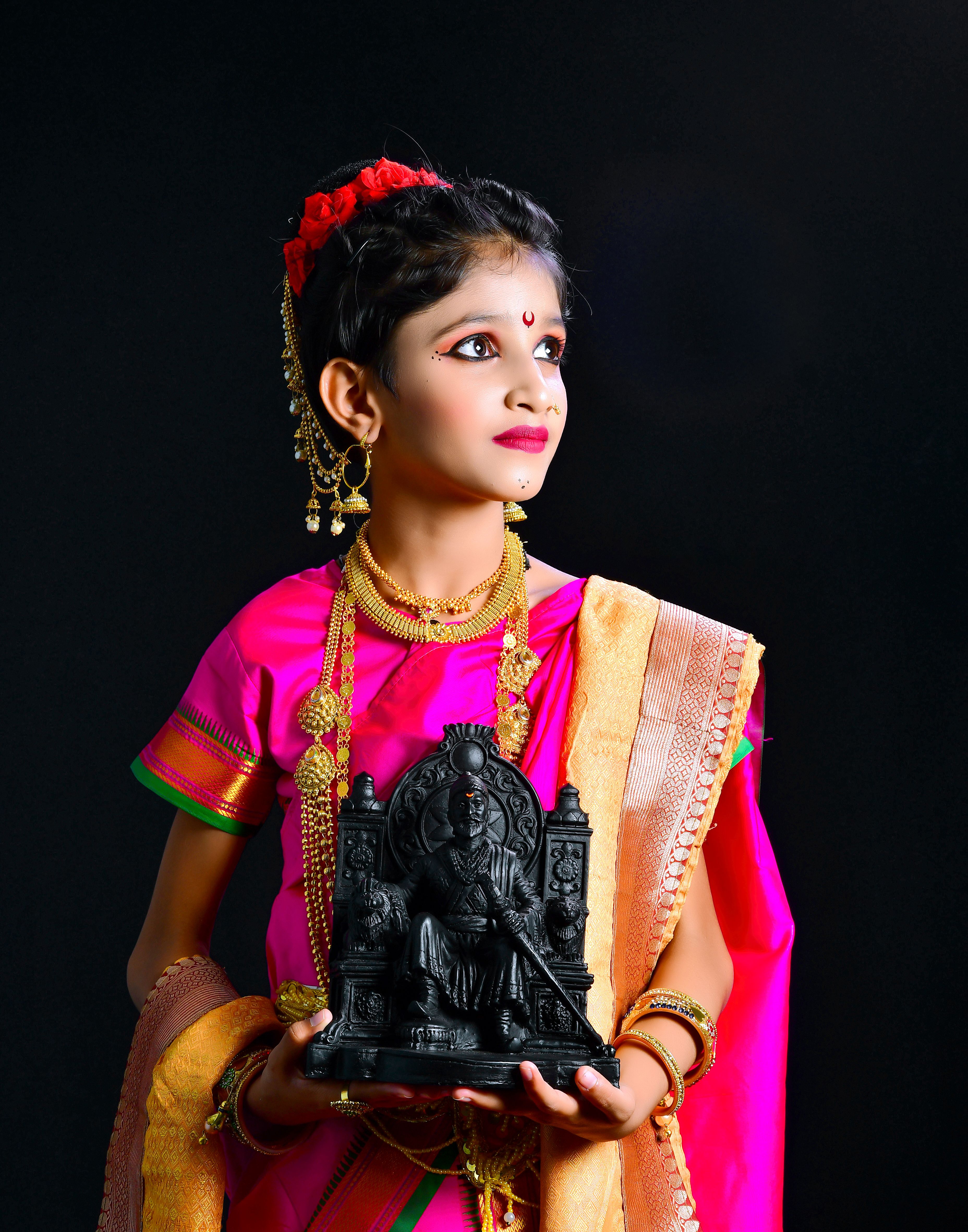 Woman Standing in Traditional Clothing and Holding Statue · Free Stock ...