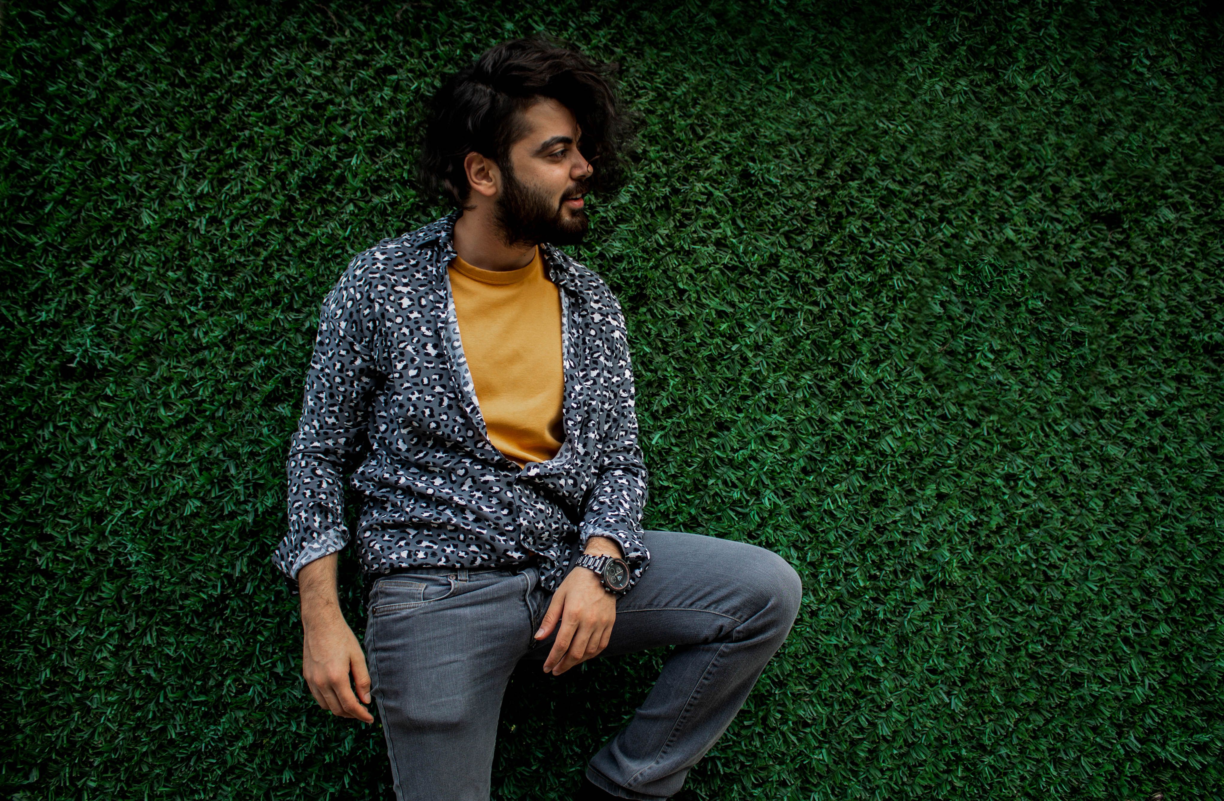 Man Standing Behind Grass Wall · Free Stock Photo