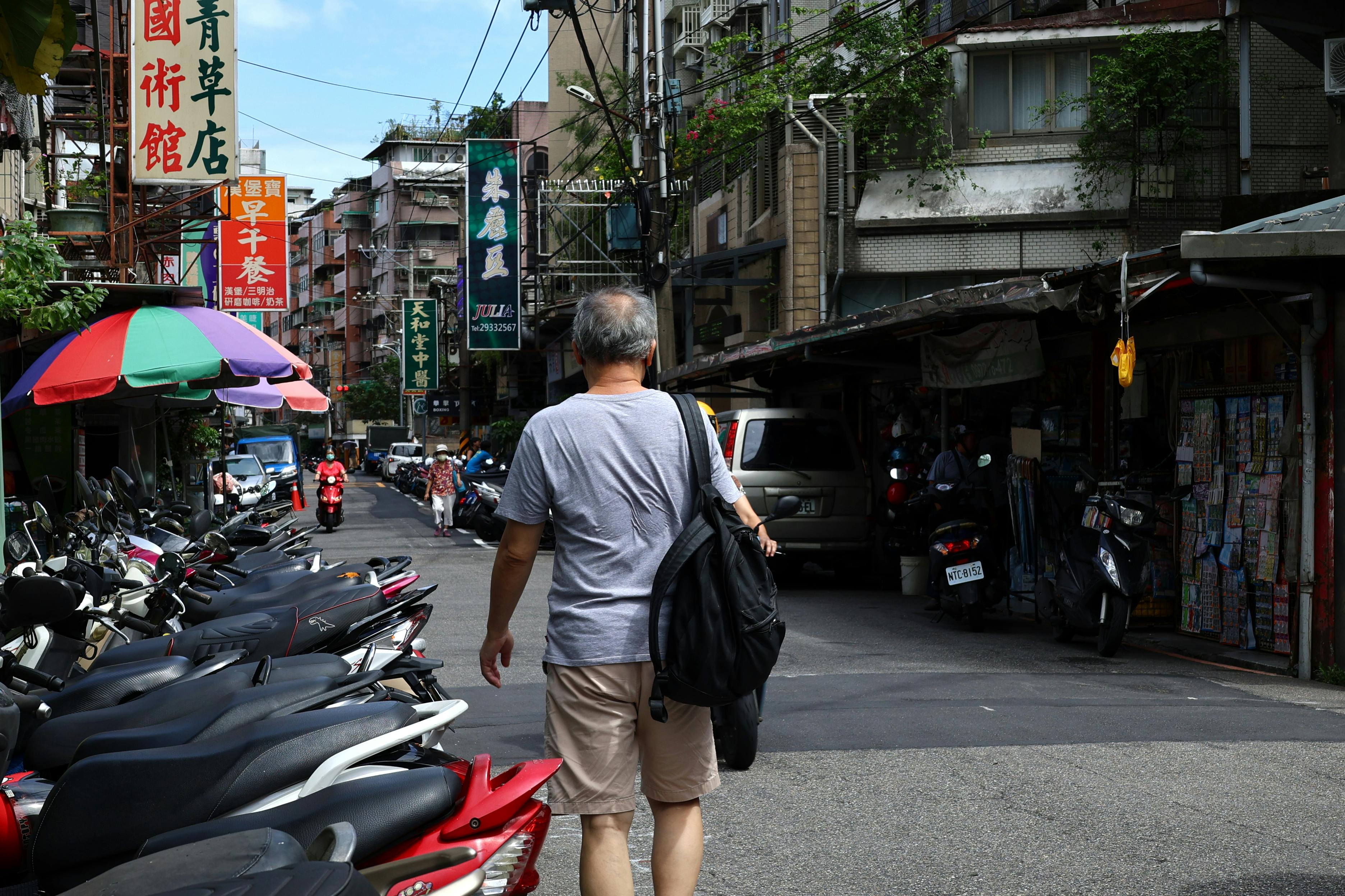 Back View of Man Walking on Street · Free Stock Photo