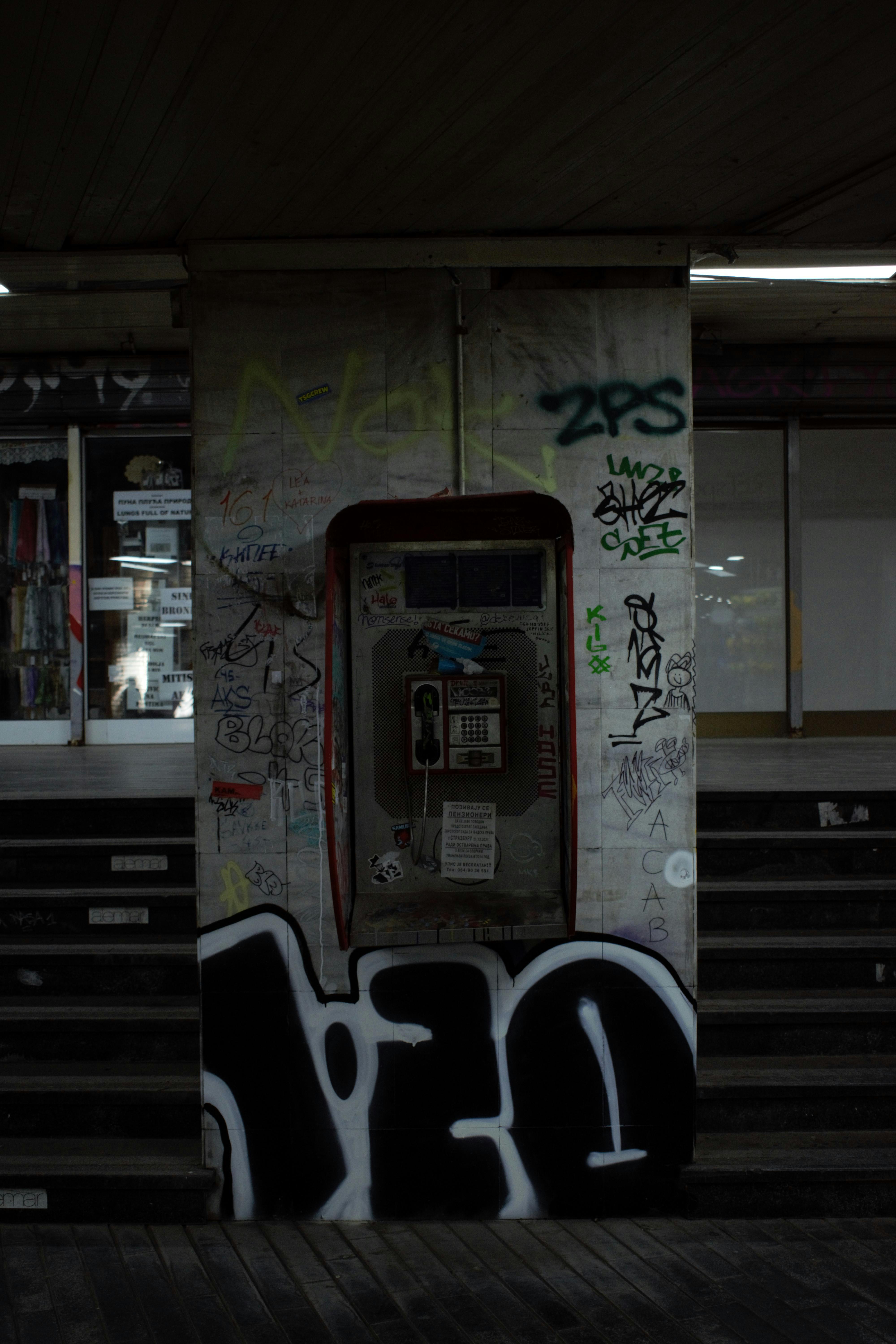 Telephone Booth on Wall with Graffiti · Free Stock Photo