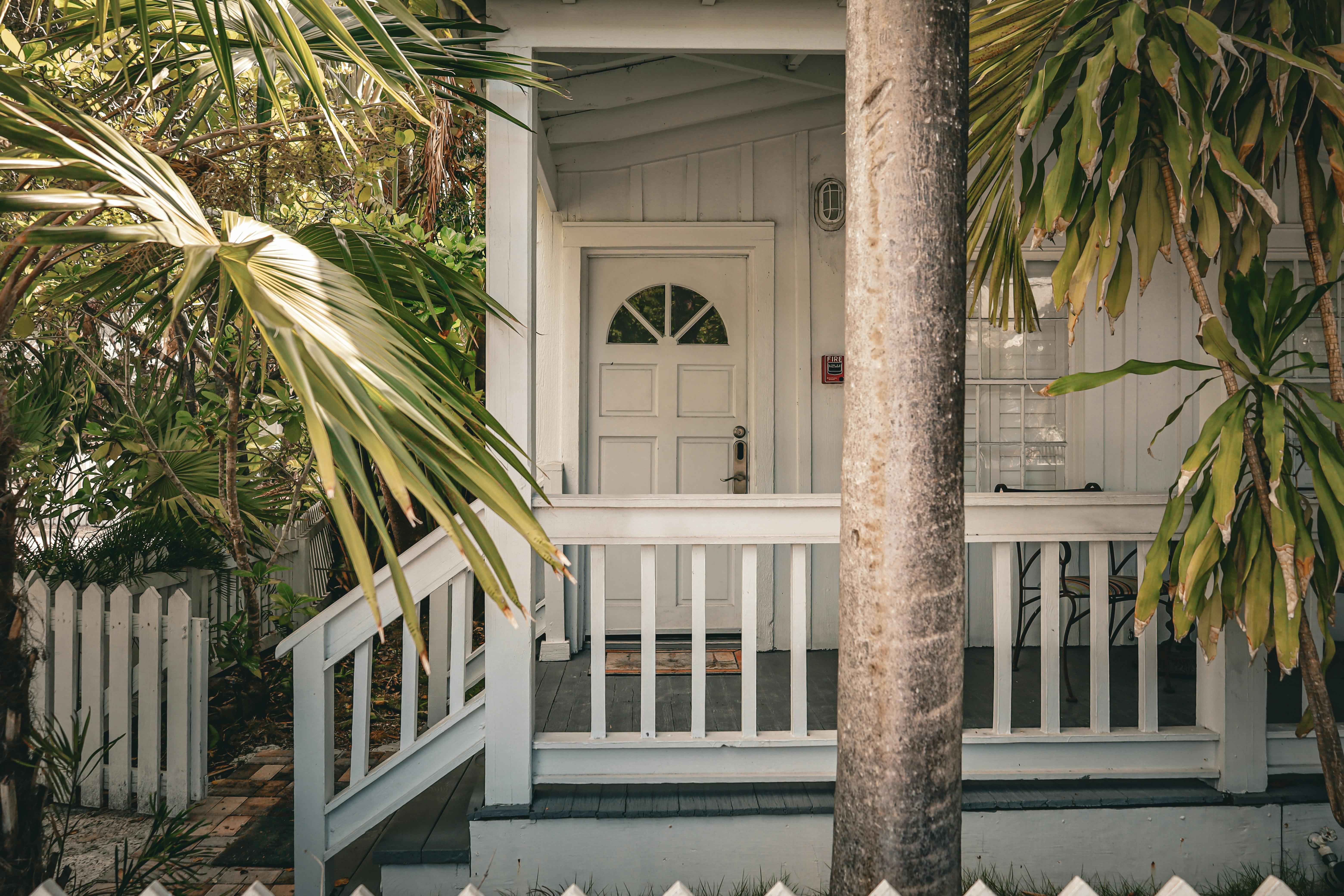 A Porch and Entrance to a House with Palm Trees on the Yard · Free ...