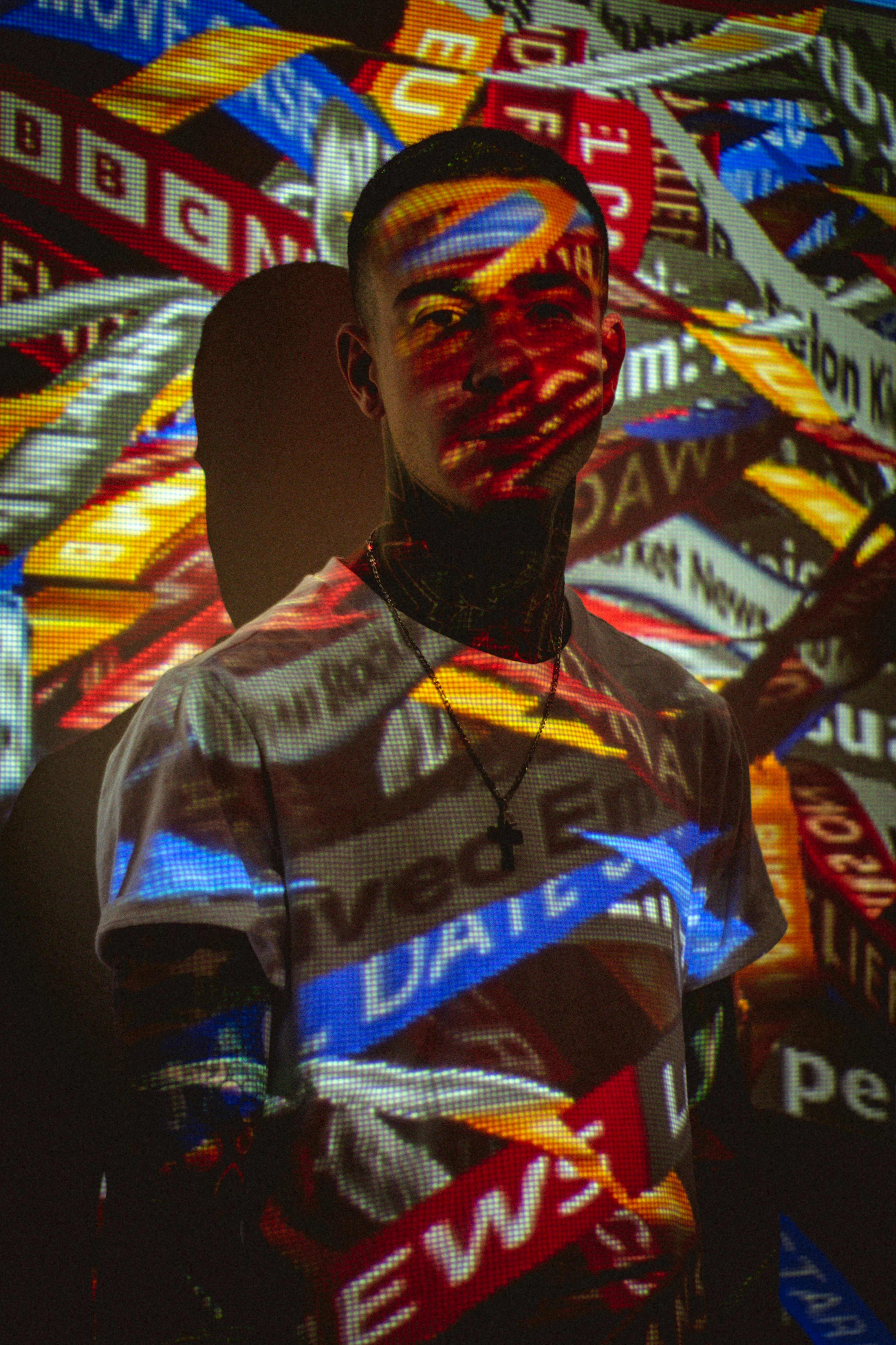 Multi Colored Labels Screening on Standing Man · Free Stock Photo