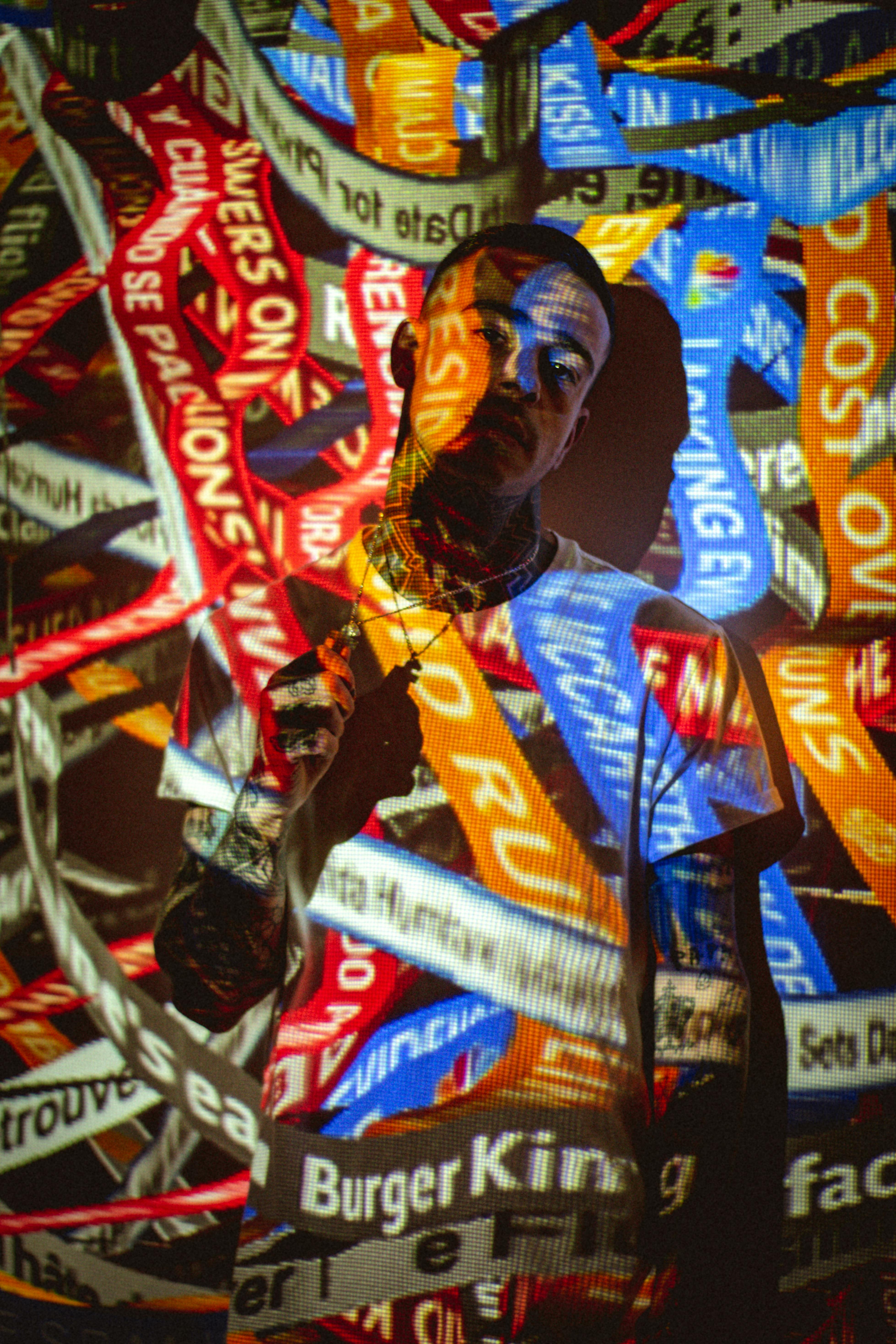 A Man on the Background of a Colorful Projection · Free Stock Photo