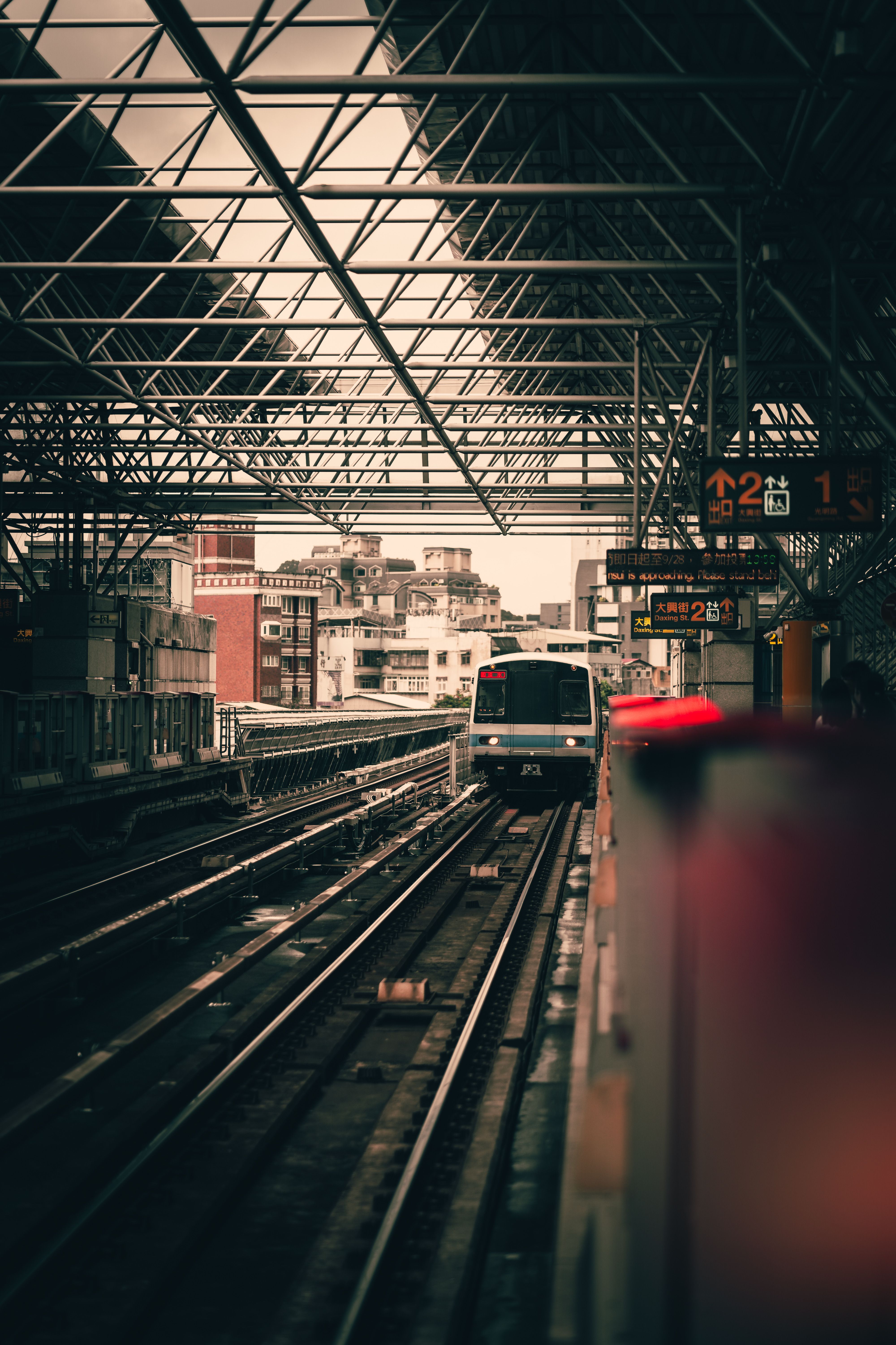 White Ceramic Tiles Near Black Train Rail · Free Stock Photo