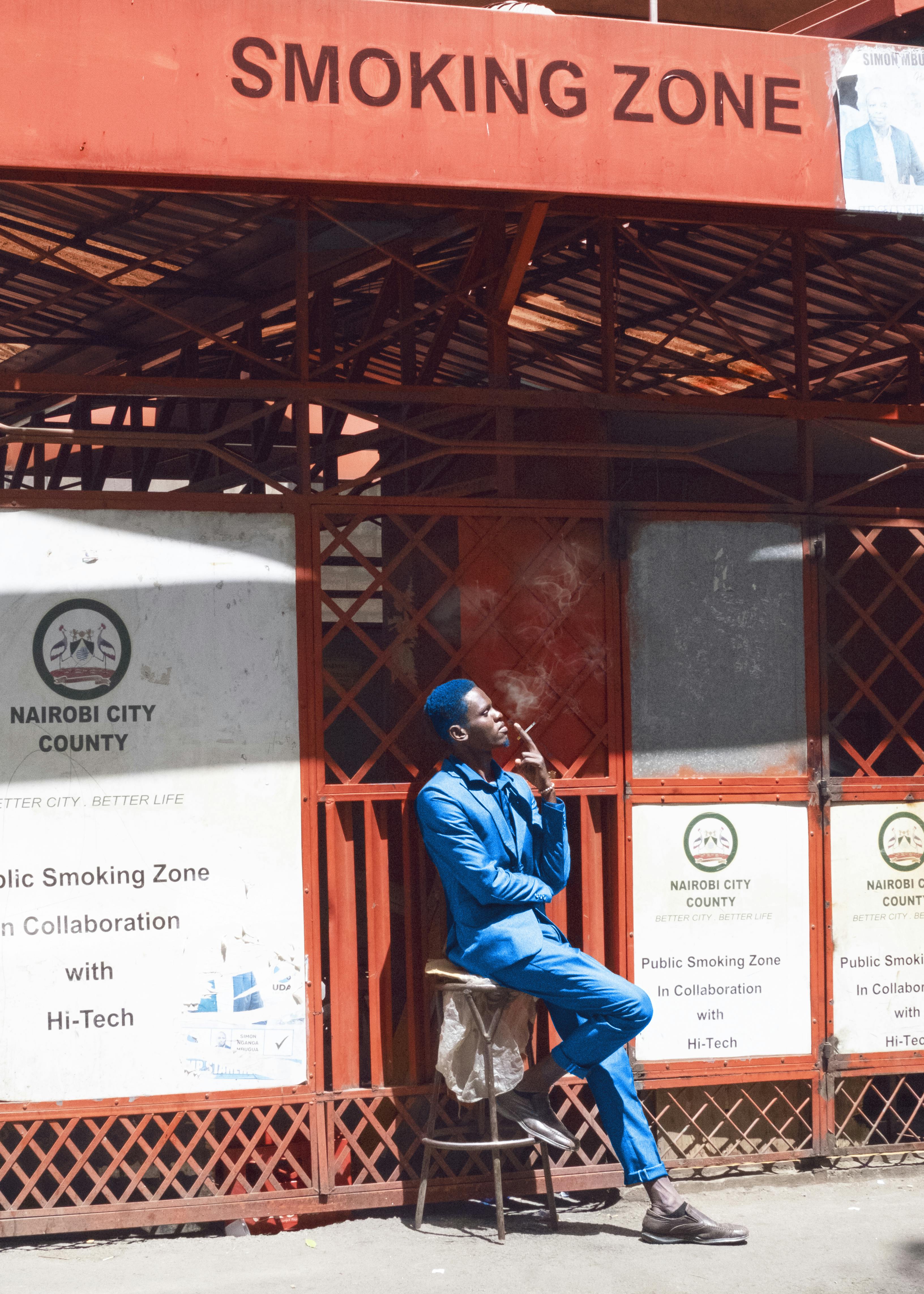 Man with Cigarette in Smoking Zone · Free Stock Photo