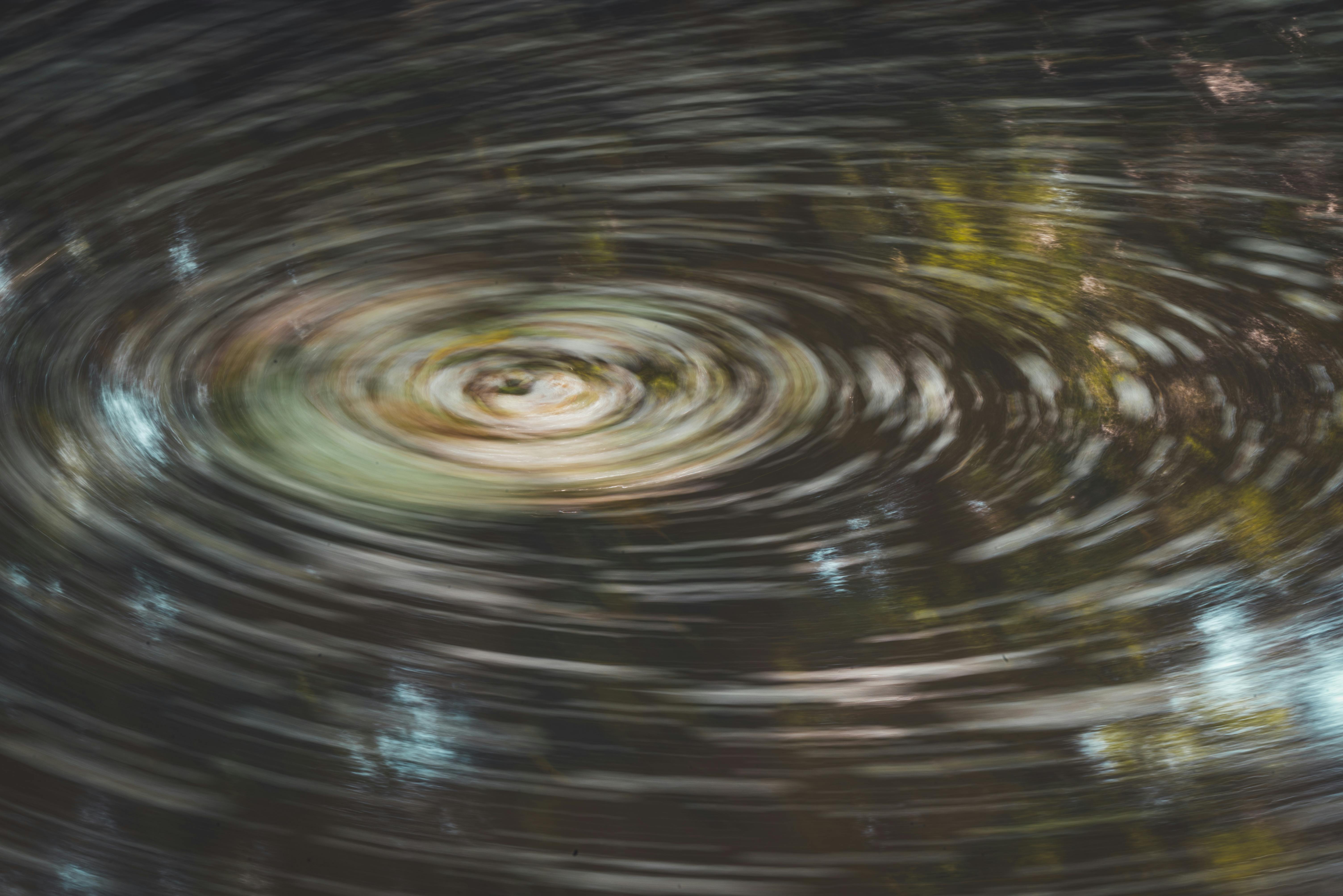 Timelapse of Water Around a Whirlpool in a Pond · Free Stock Photo