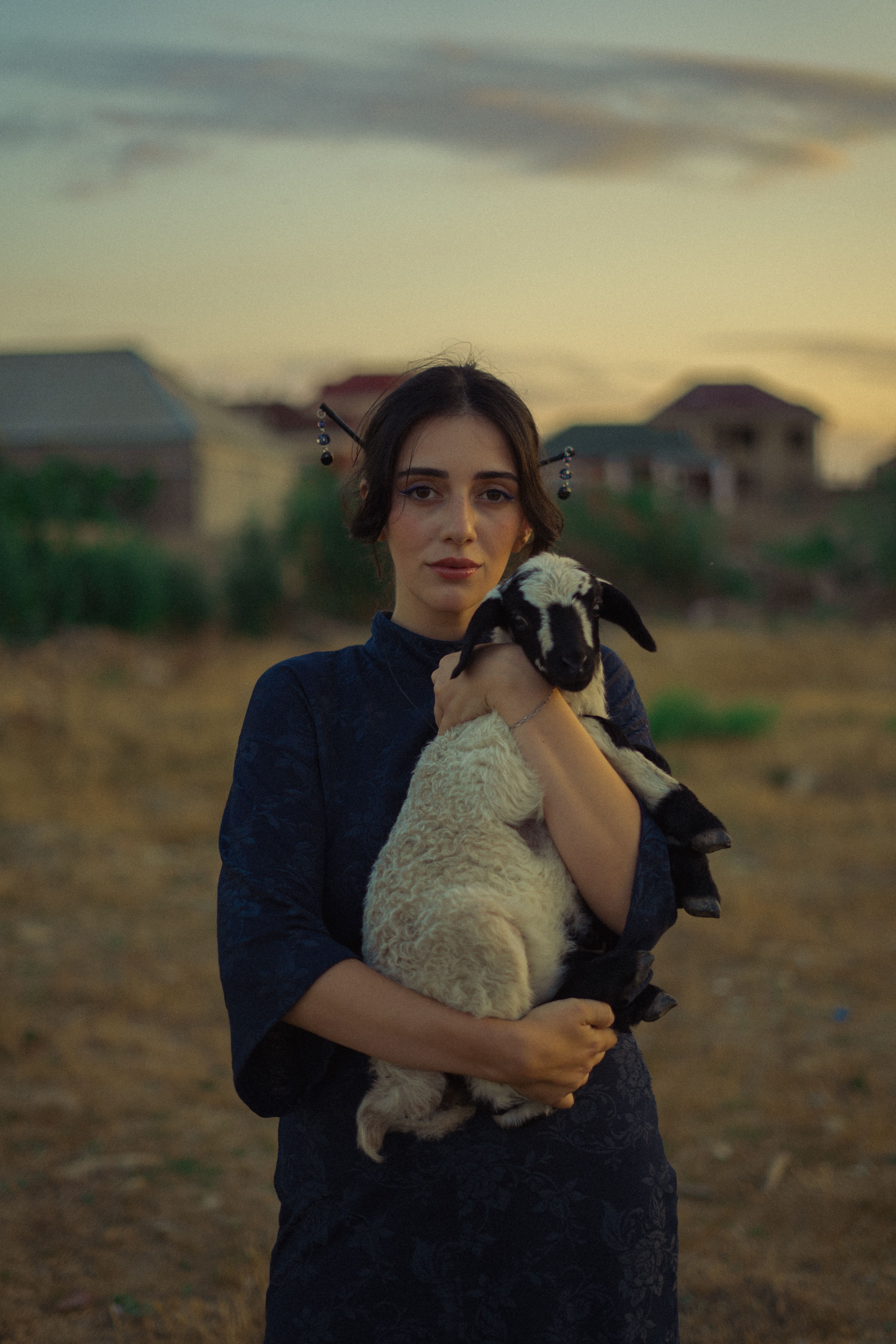 Young Woman in Blue Retro Dress Holding a Lamb · Free Stock Photo