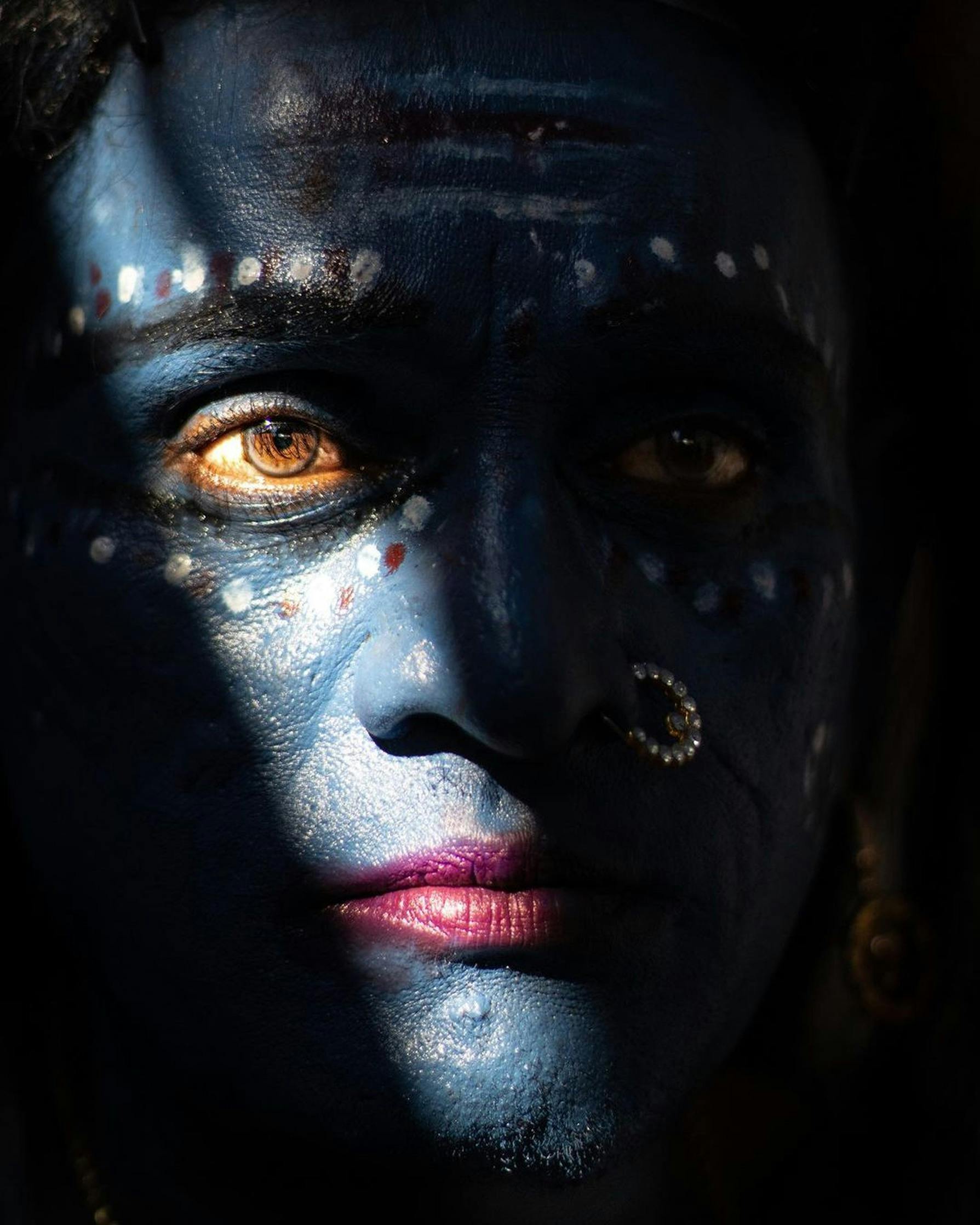 Painted Face of Man in Shadow · Free Stock Photo